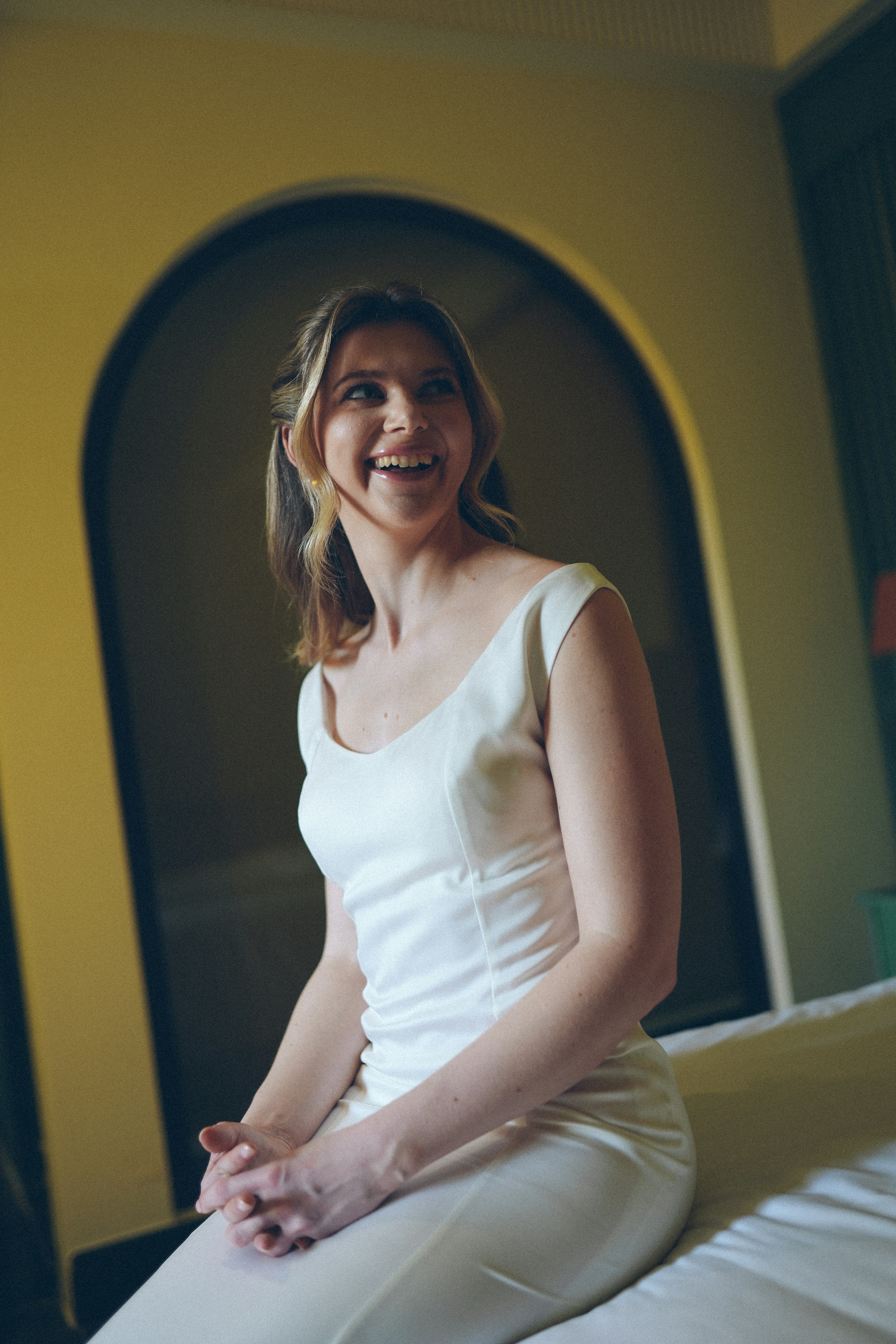 Joyful Bride in Soft Light by the Archway
