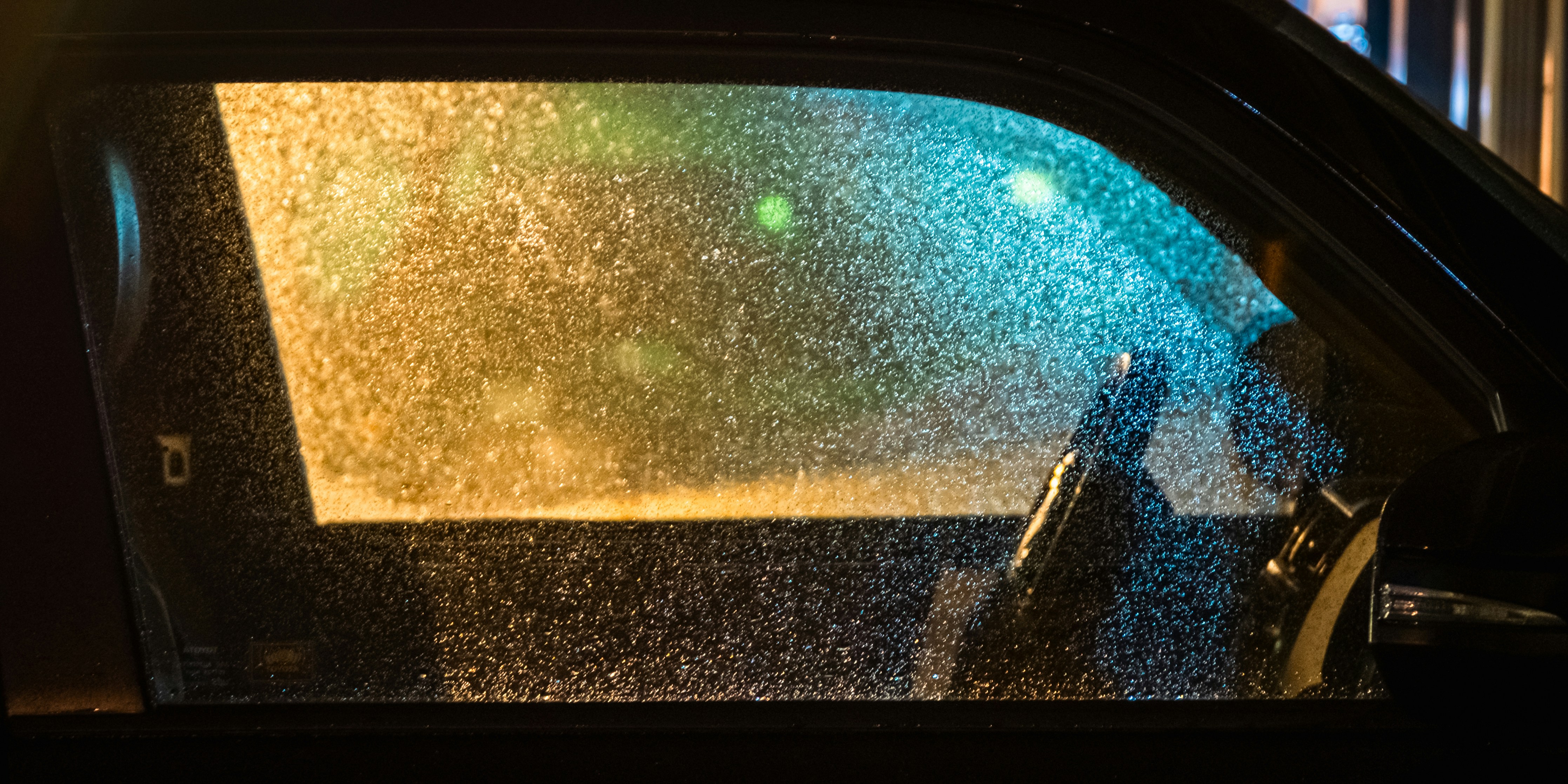 Fogged Car Window at Night: Water Droplets and Neon Reflections