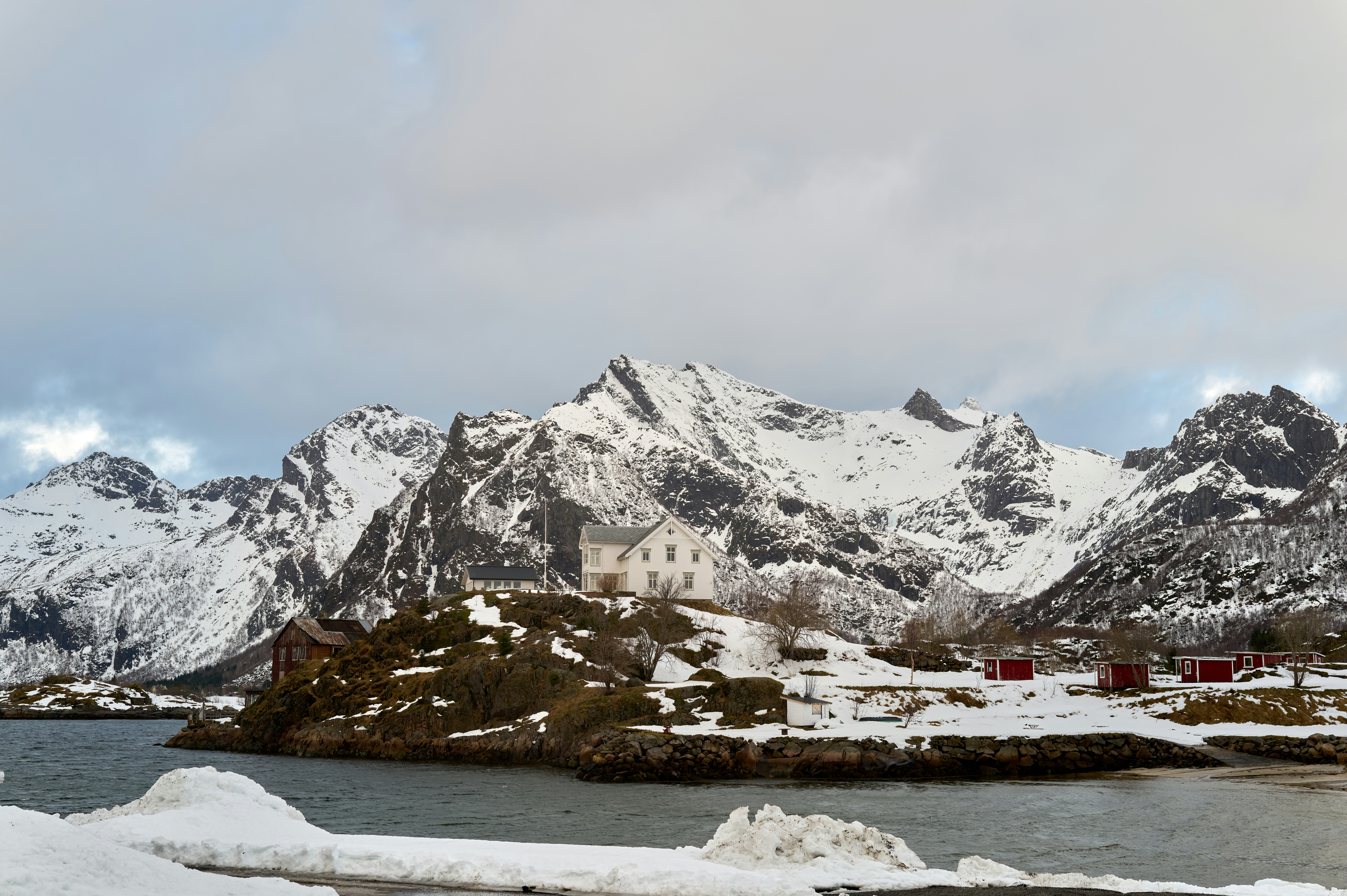 Snowbound Village Nestled Against Rugged Peaks