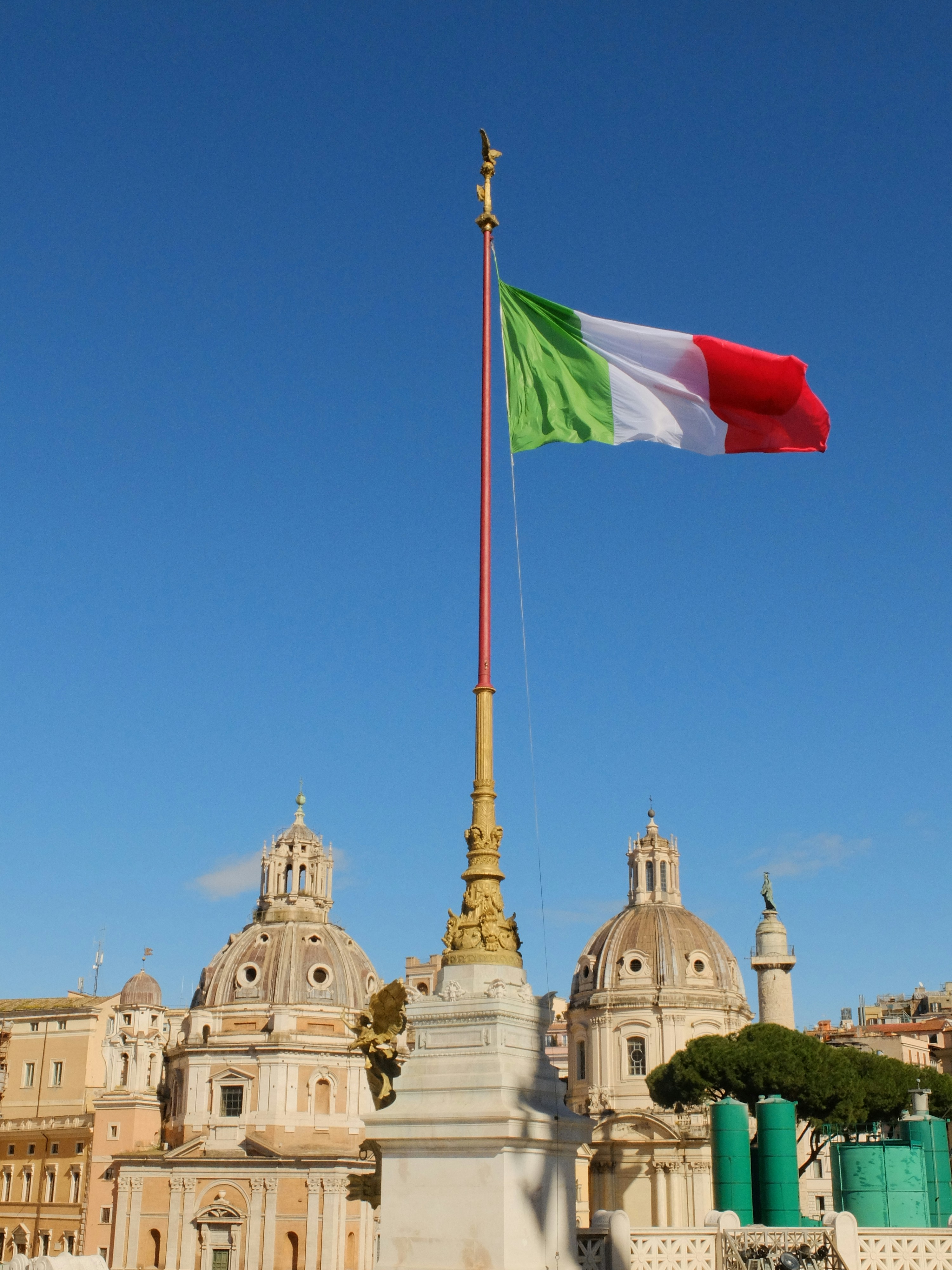 Flag Over the Roman Skyline: A Moment at Piazza Navona