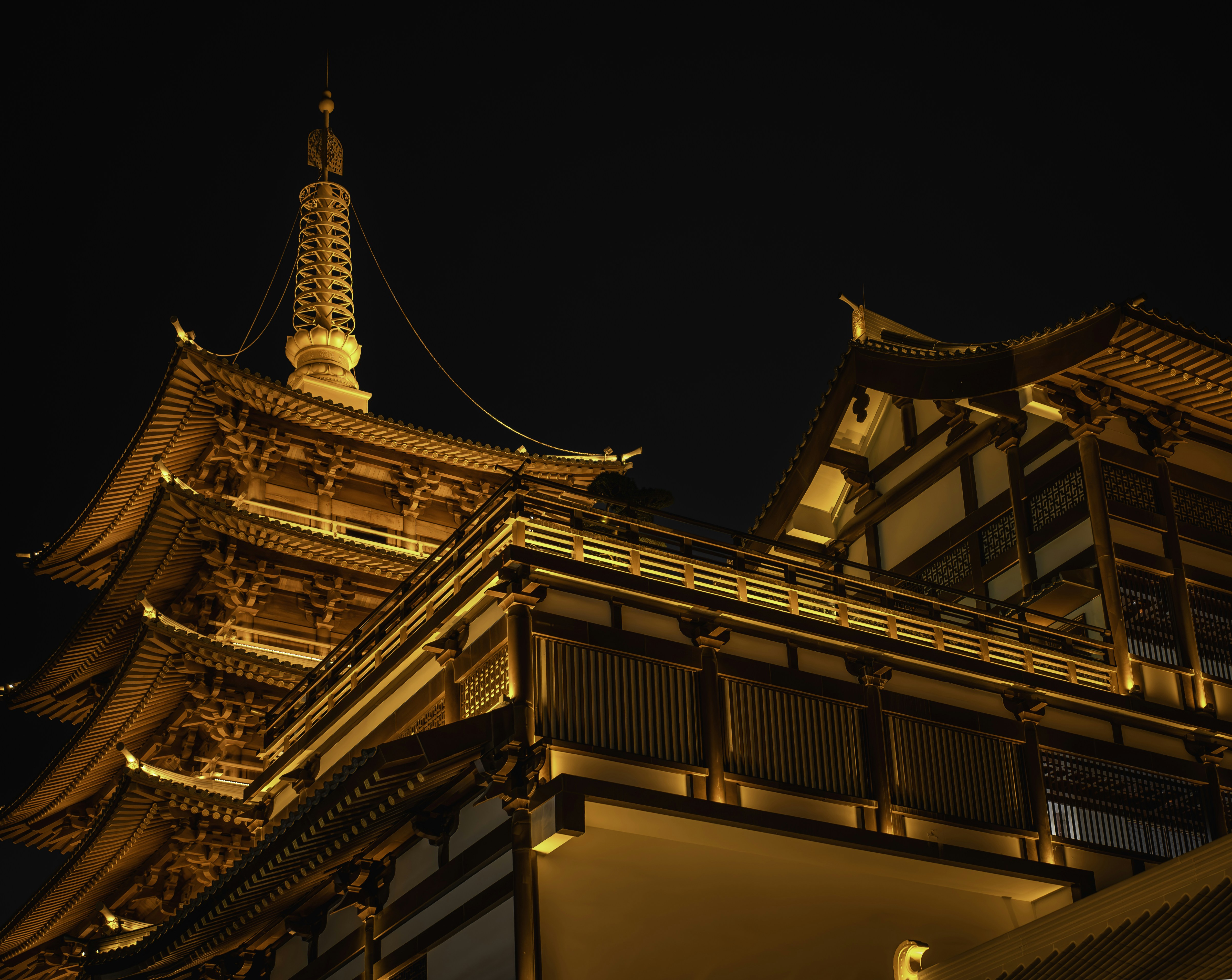 Golden Temple Silhouette: Nightglow on Tiered Rooflines