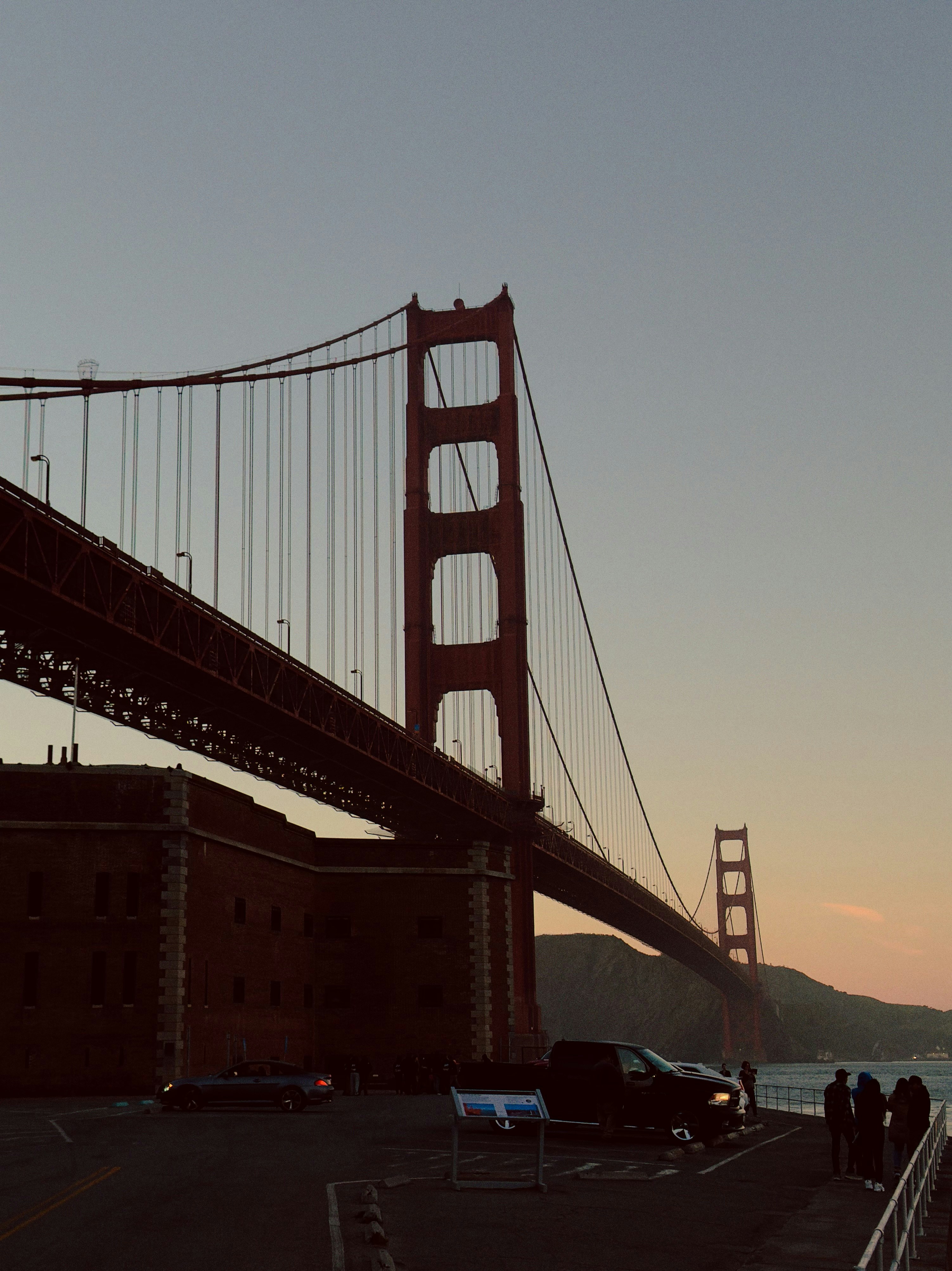 Golden Gate at Dusk: Bridge Towers silhouetted over quiet waterfront