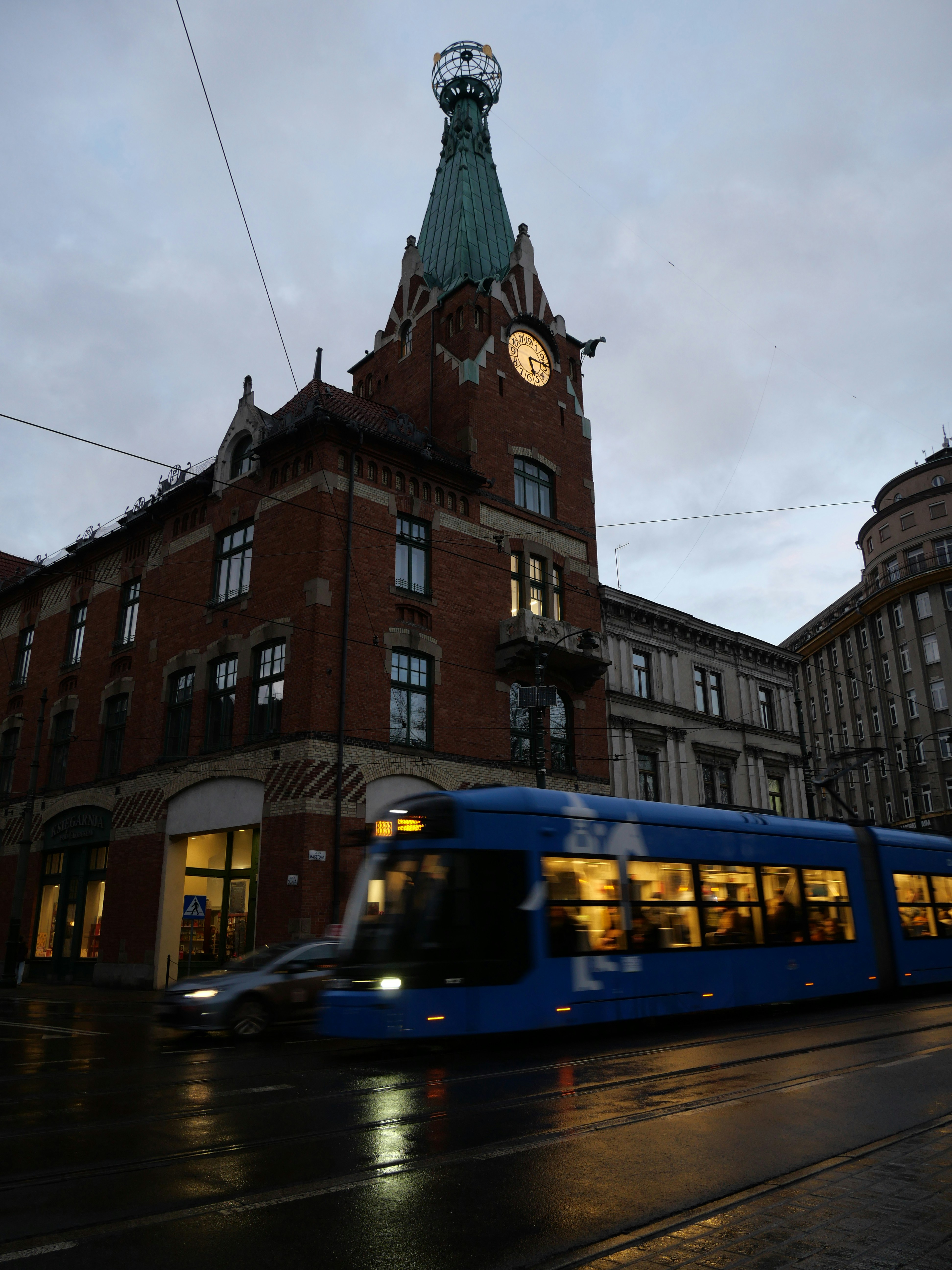 Clocktowered City Street with Blue Tram in Rain