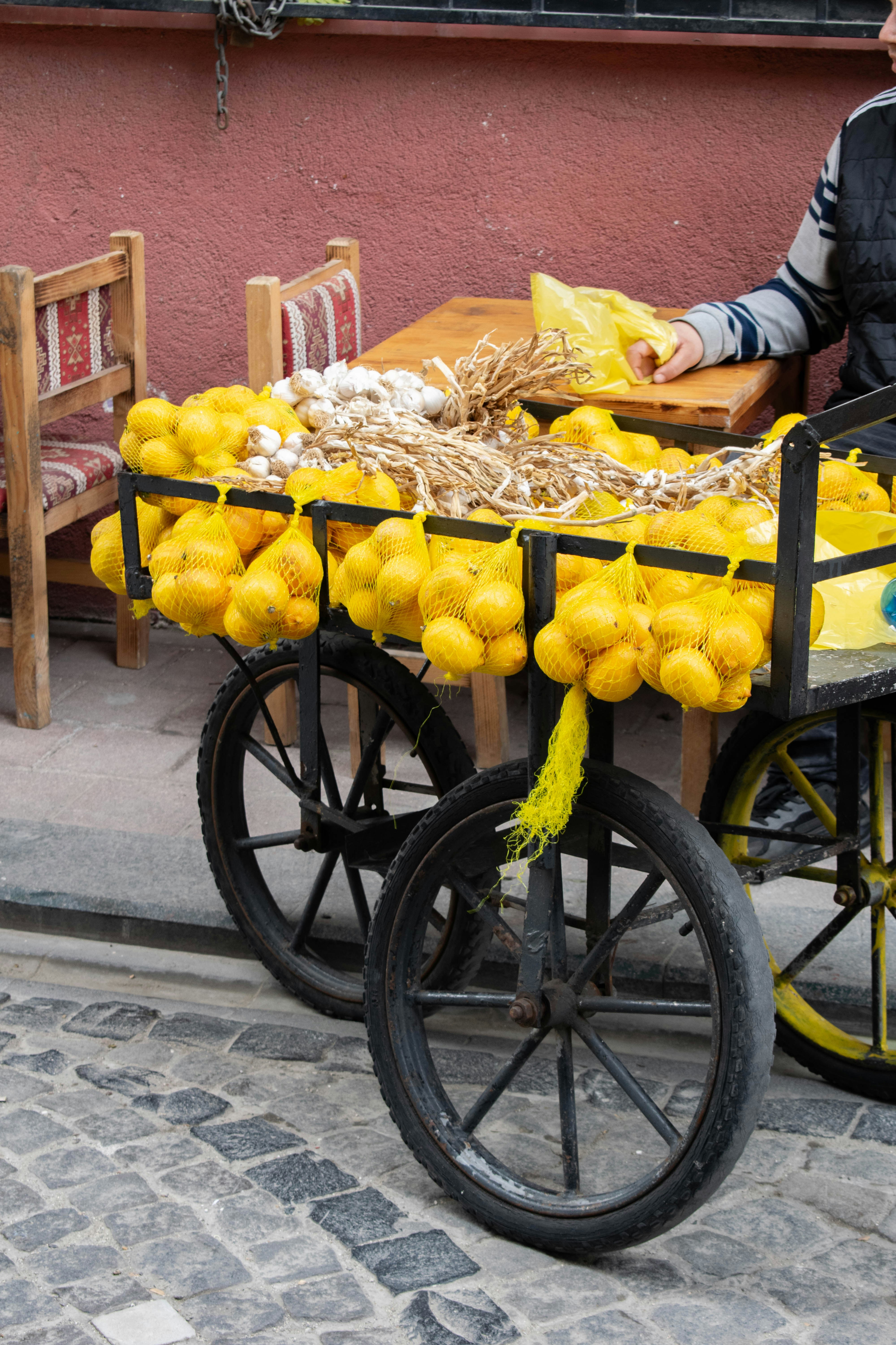Yellow Produce Cart on a Cobblestone Street