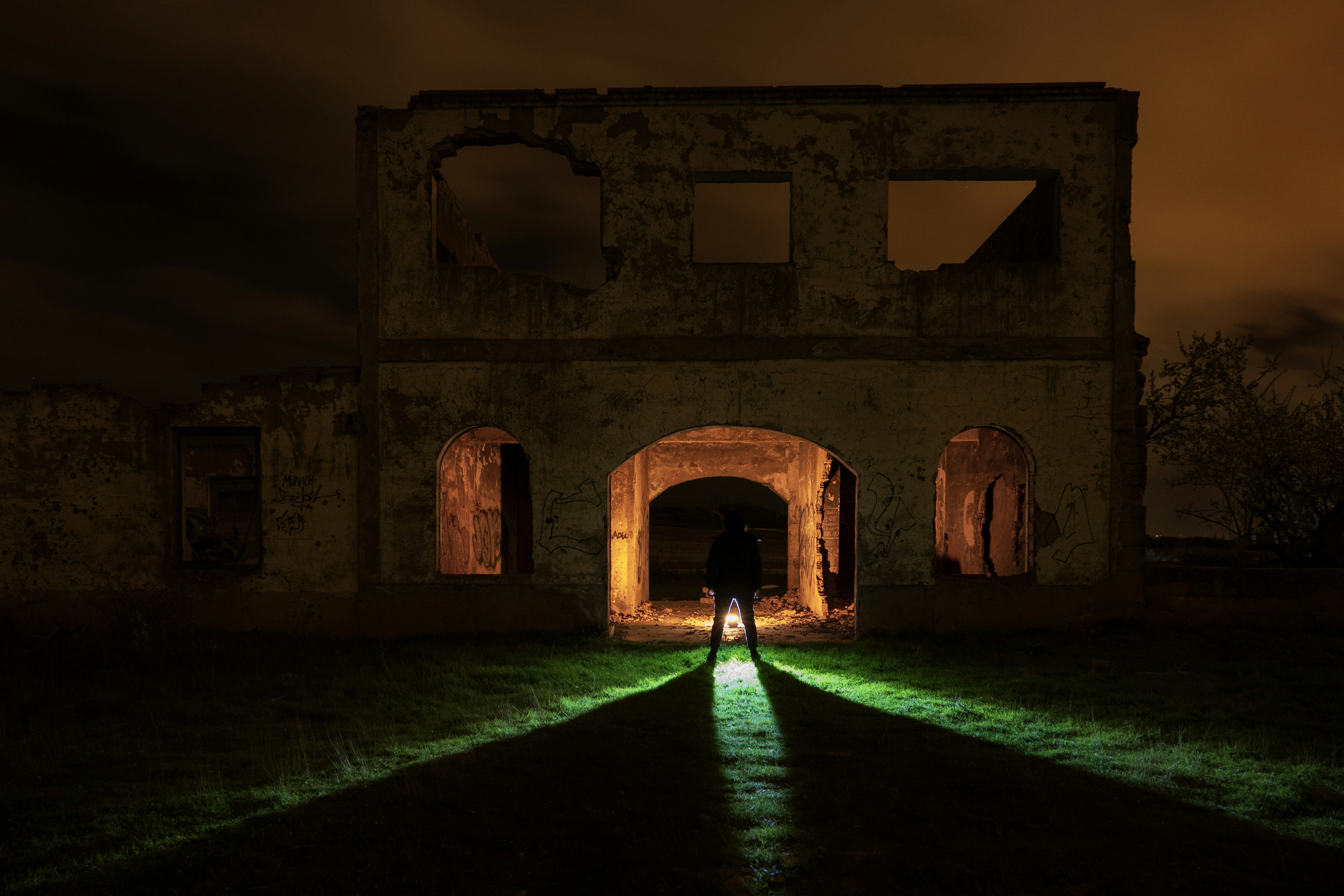 Midnight Gatekeeper: A Lone Figure Looms in the Ruined Hall