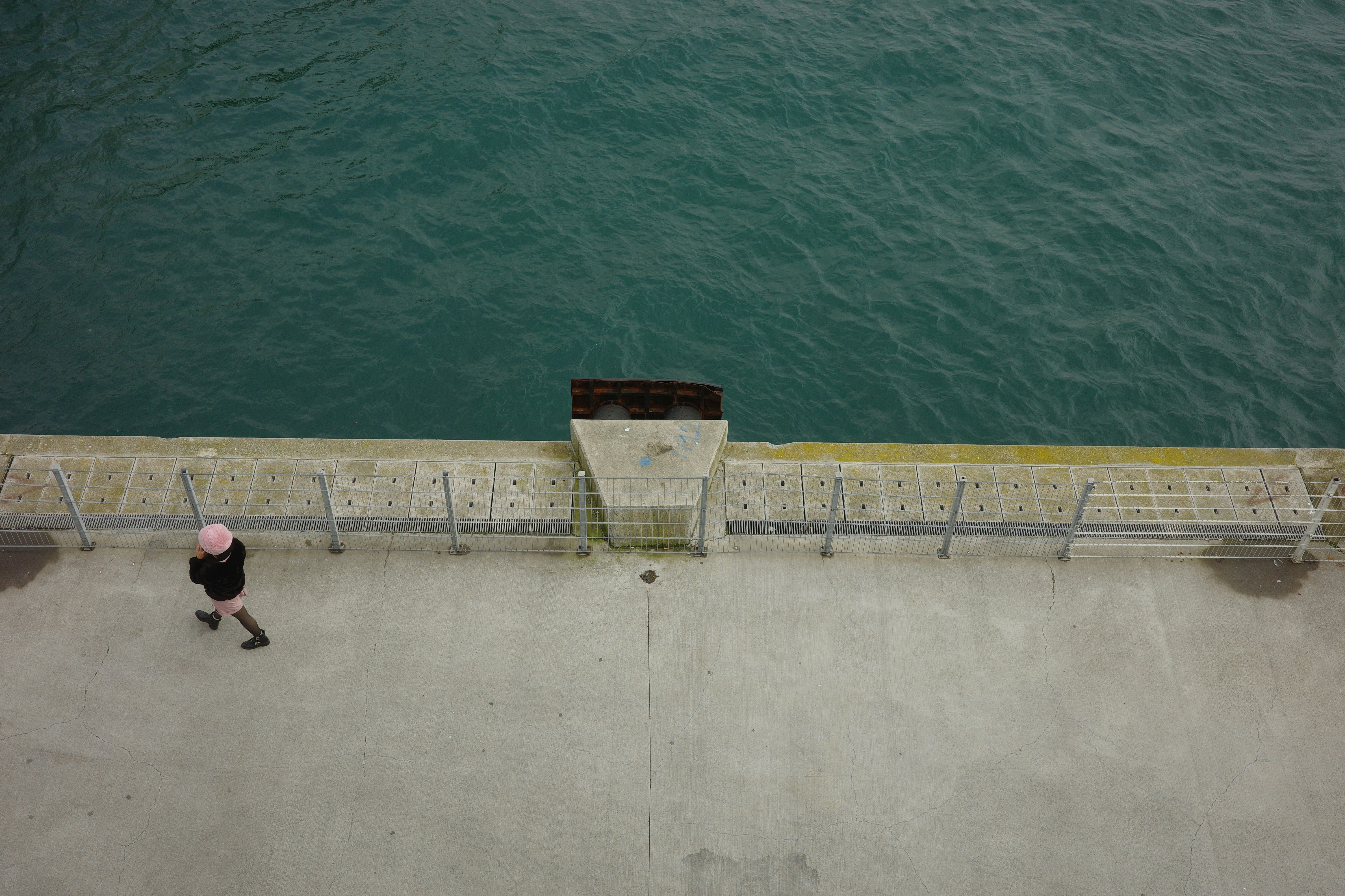  lone jogger along a quiet harbor edge