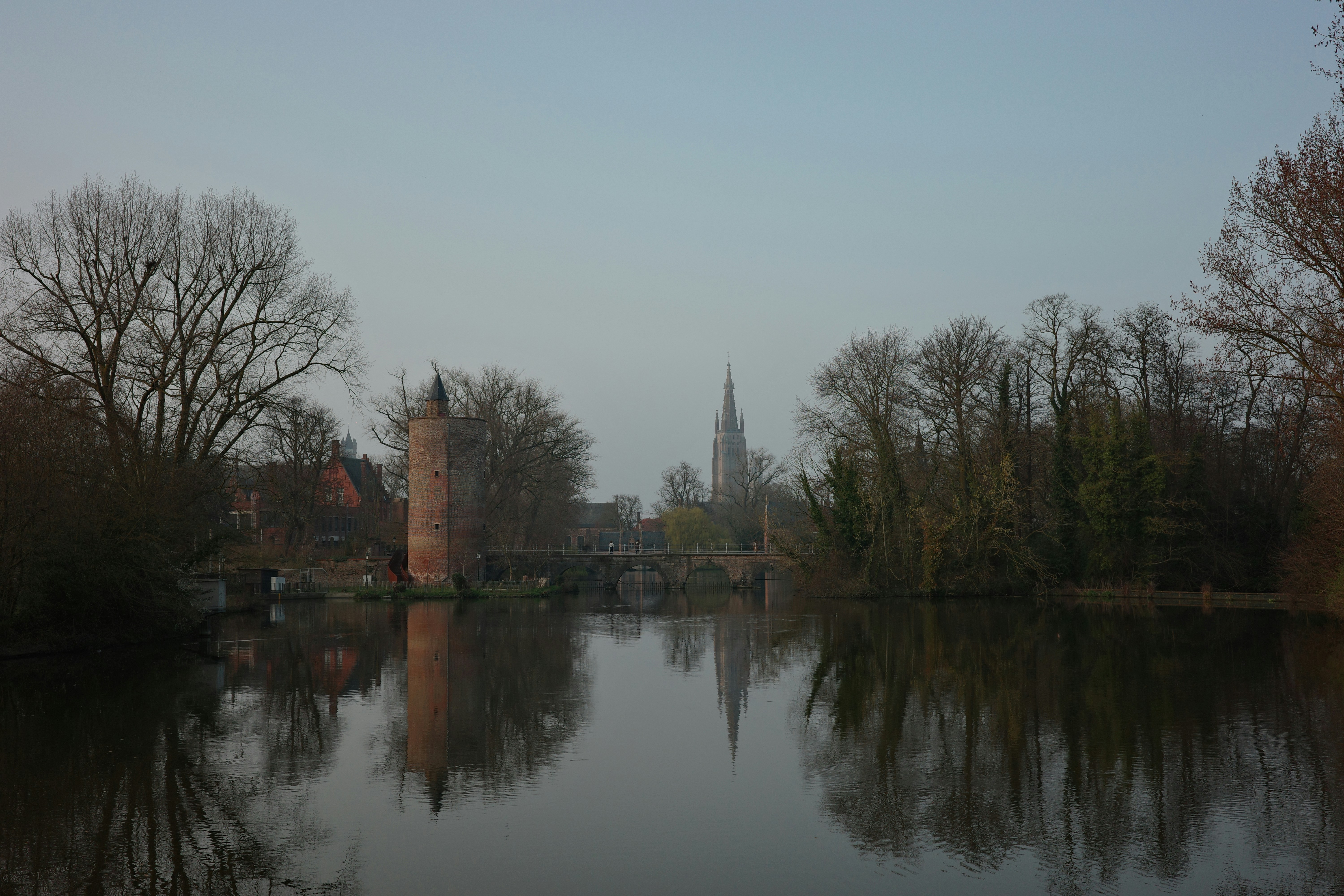Tower and church skyline rising from a calm river