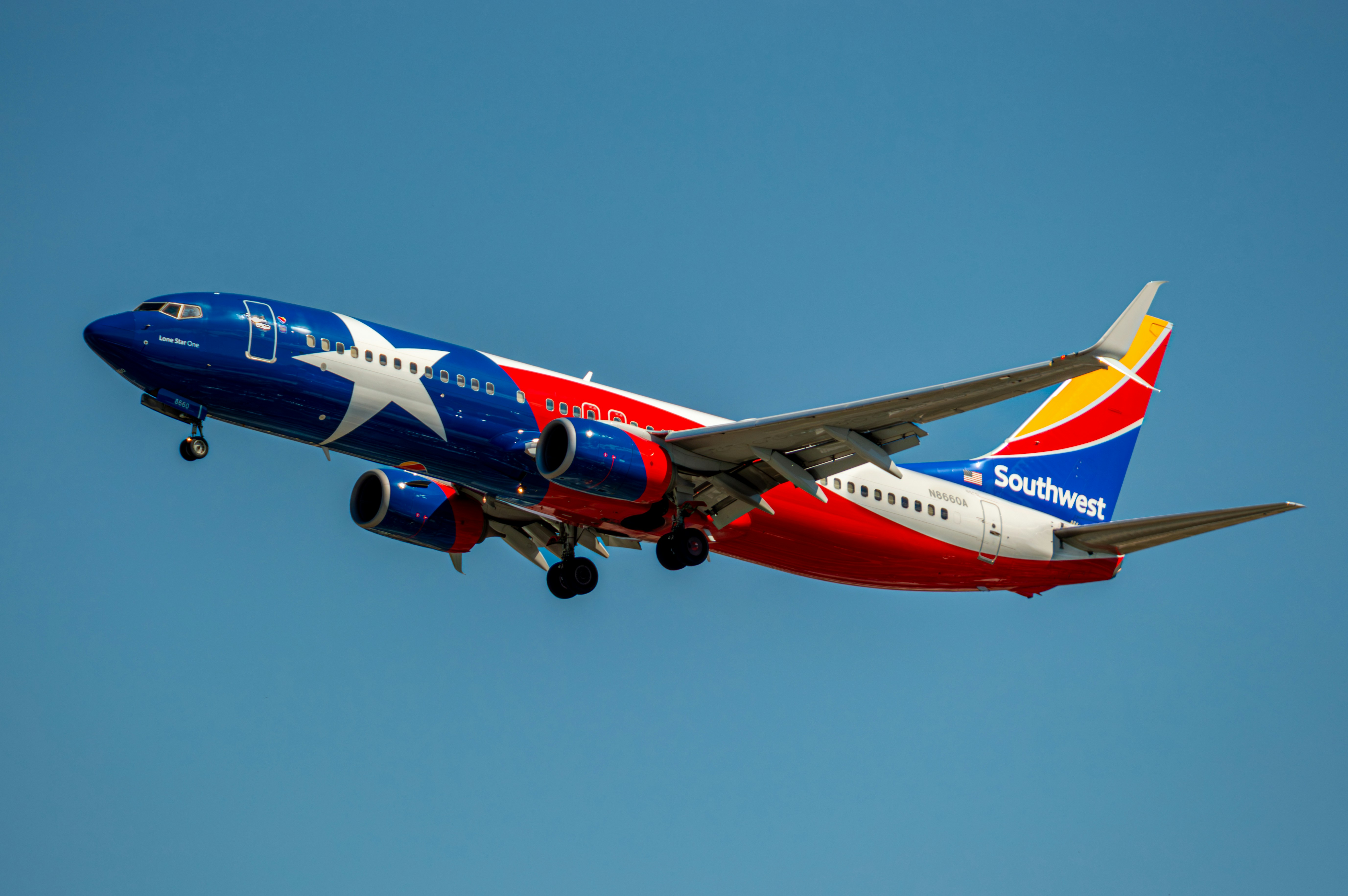 Southwest Jet Learns the Sky: A Bold Belly of Color Against Clear Blue