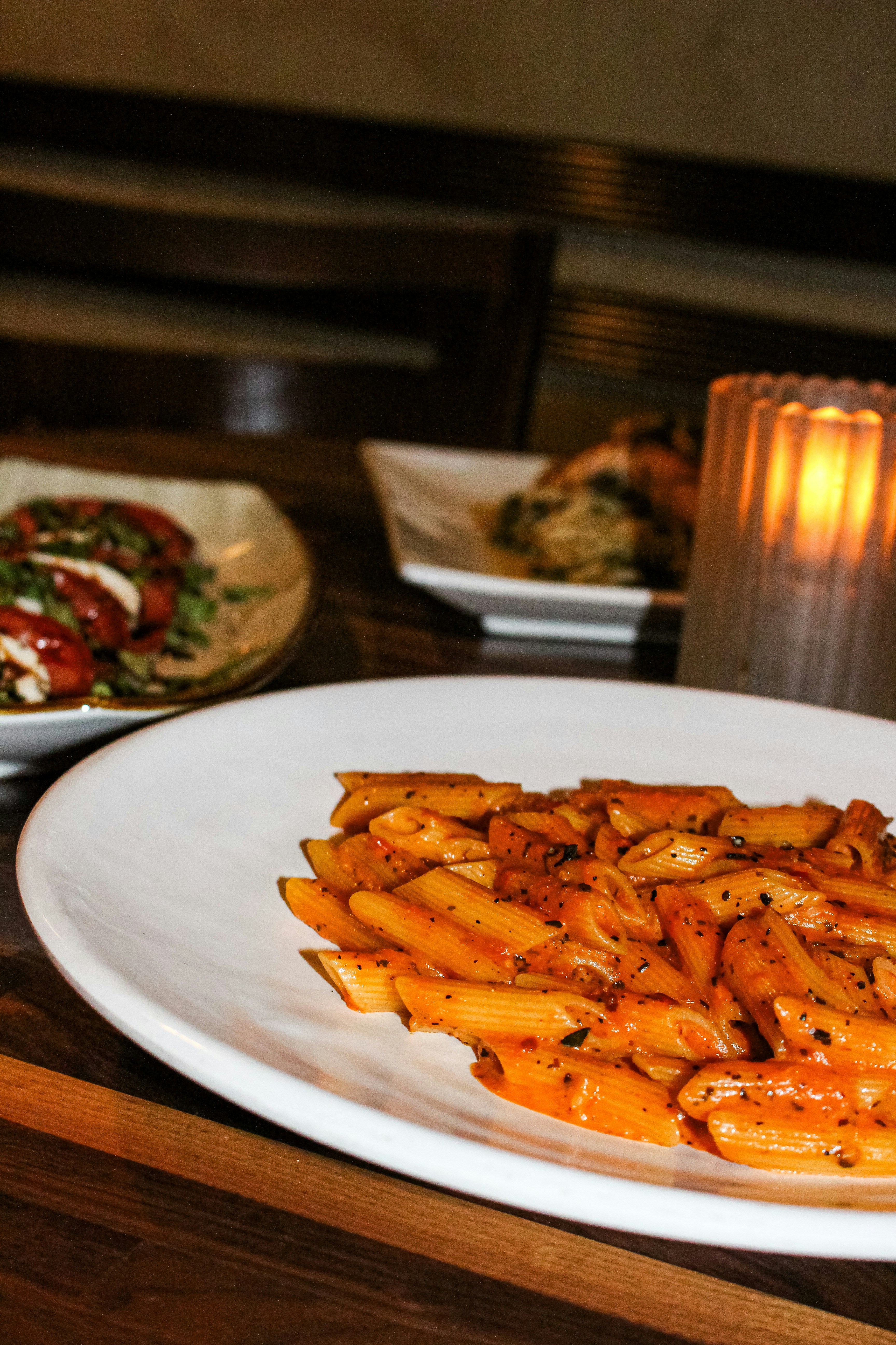 Creamy Tomato-Pushed Penne: A Close-Up of Golden-Penned Pasta on a White Plate