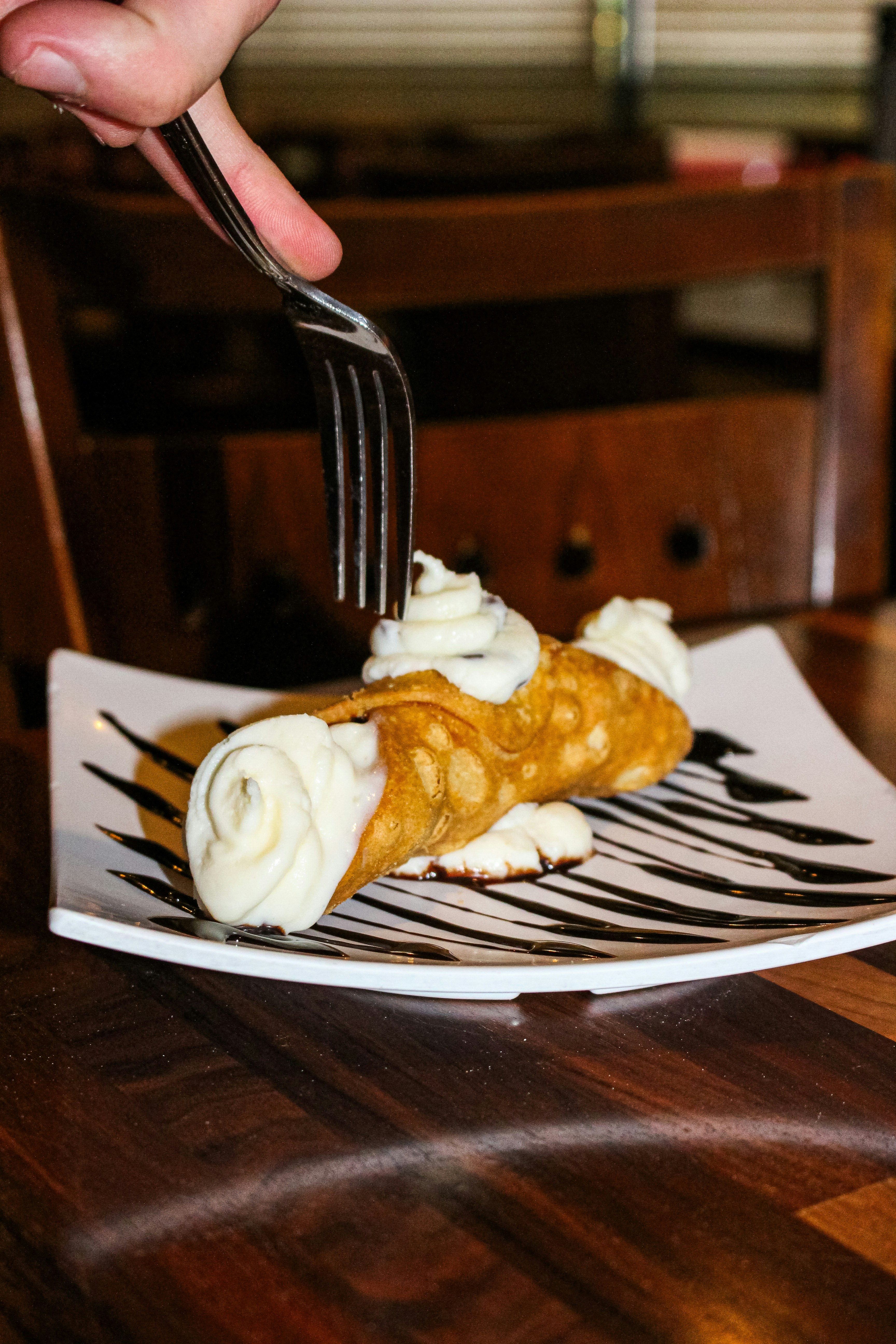 Cream‑topped churros on a decorative plate, ready to be savored