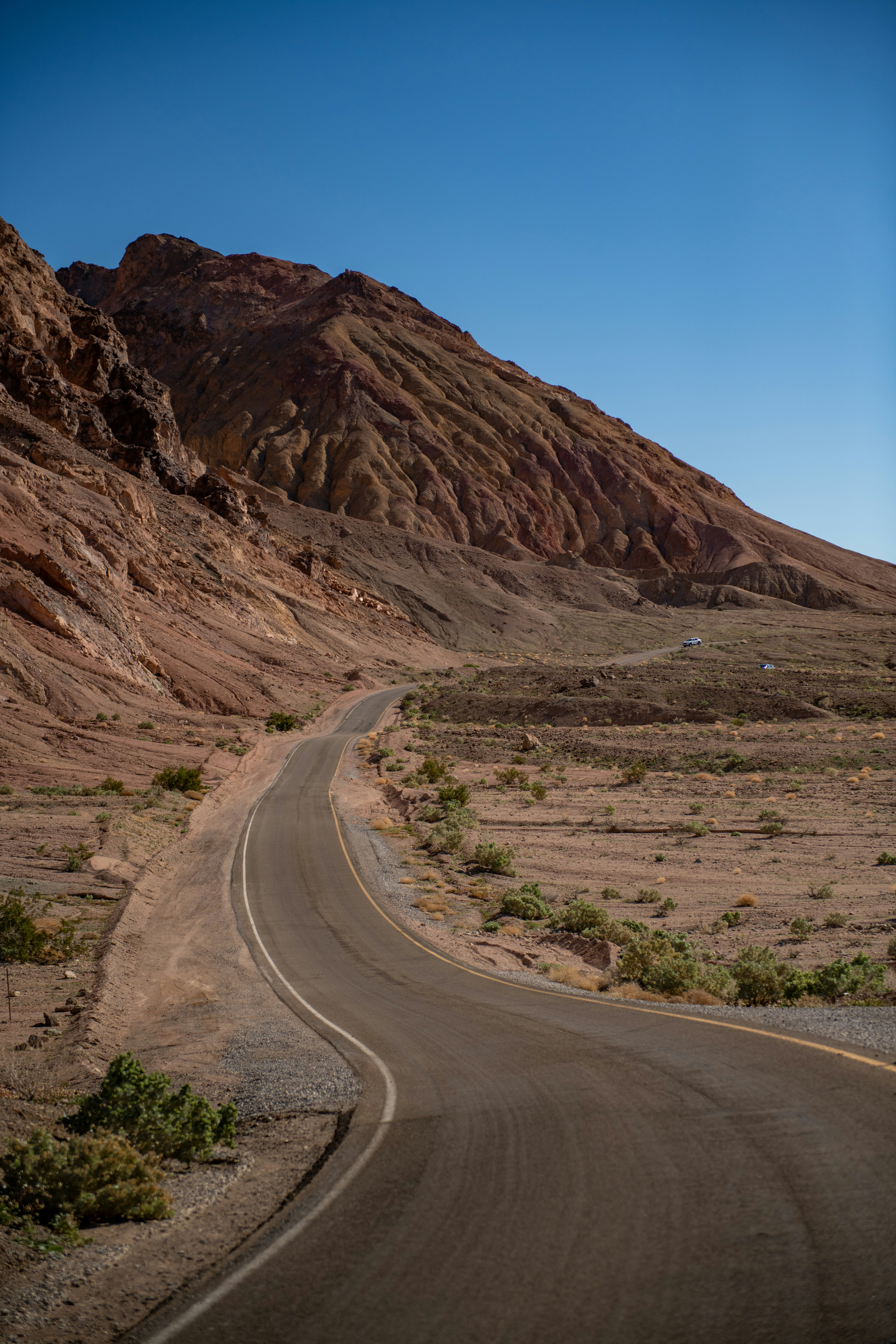 Desert Ribbon: A Winding Road Carves Through Rusted Peaks