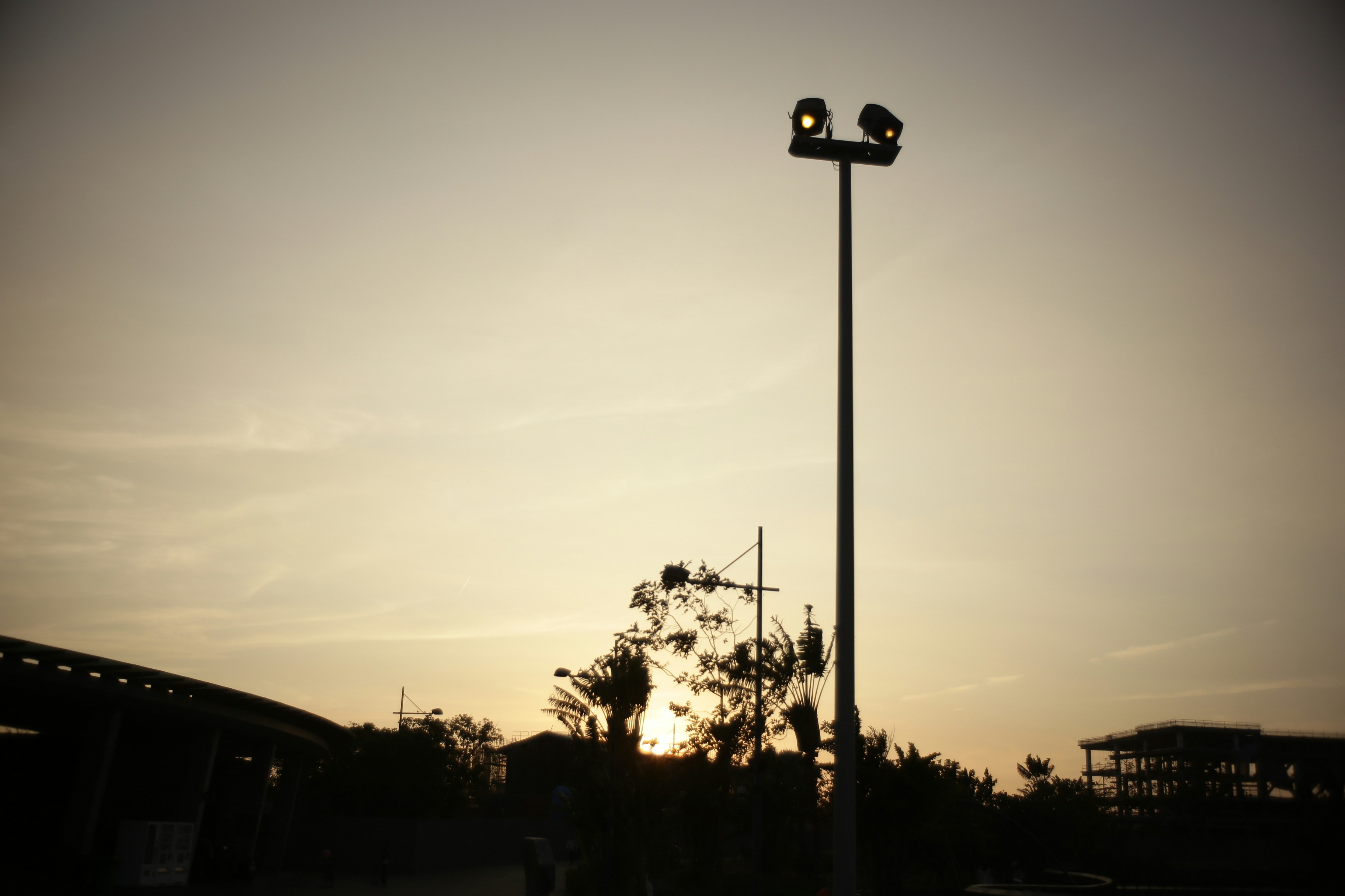 Silhouette on the Horizon: Sunset Lamps and Sparse Skyline