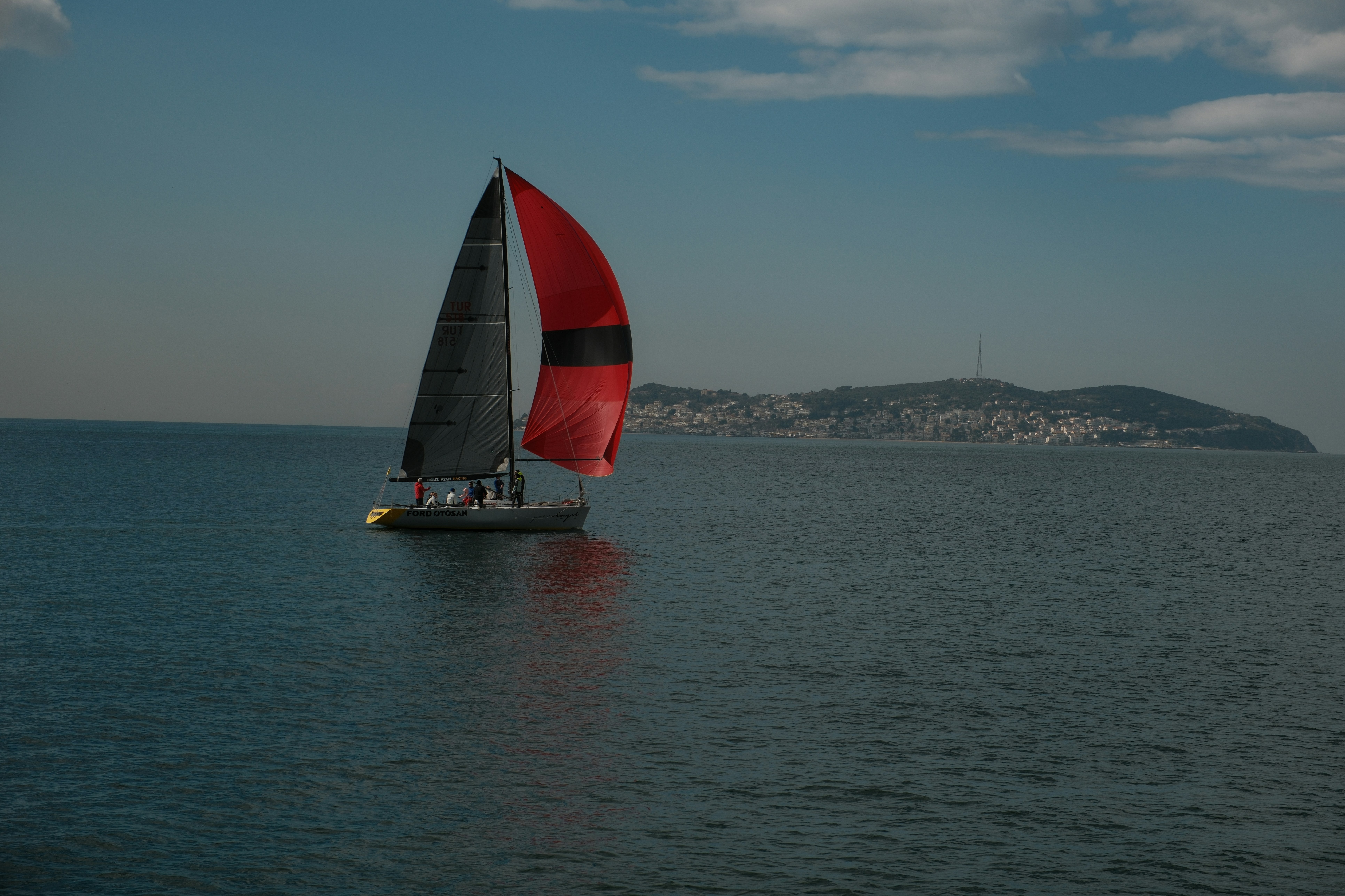 Red-sailed Catamaran on Calm Blue Waters