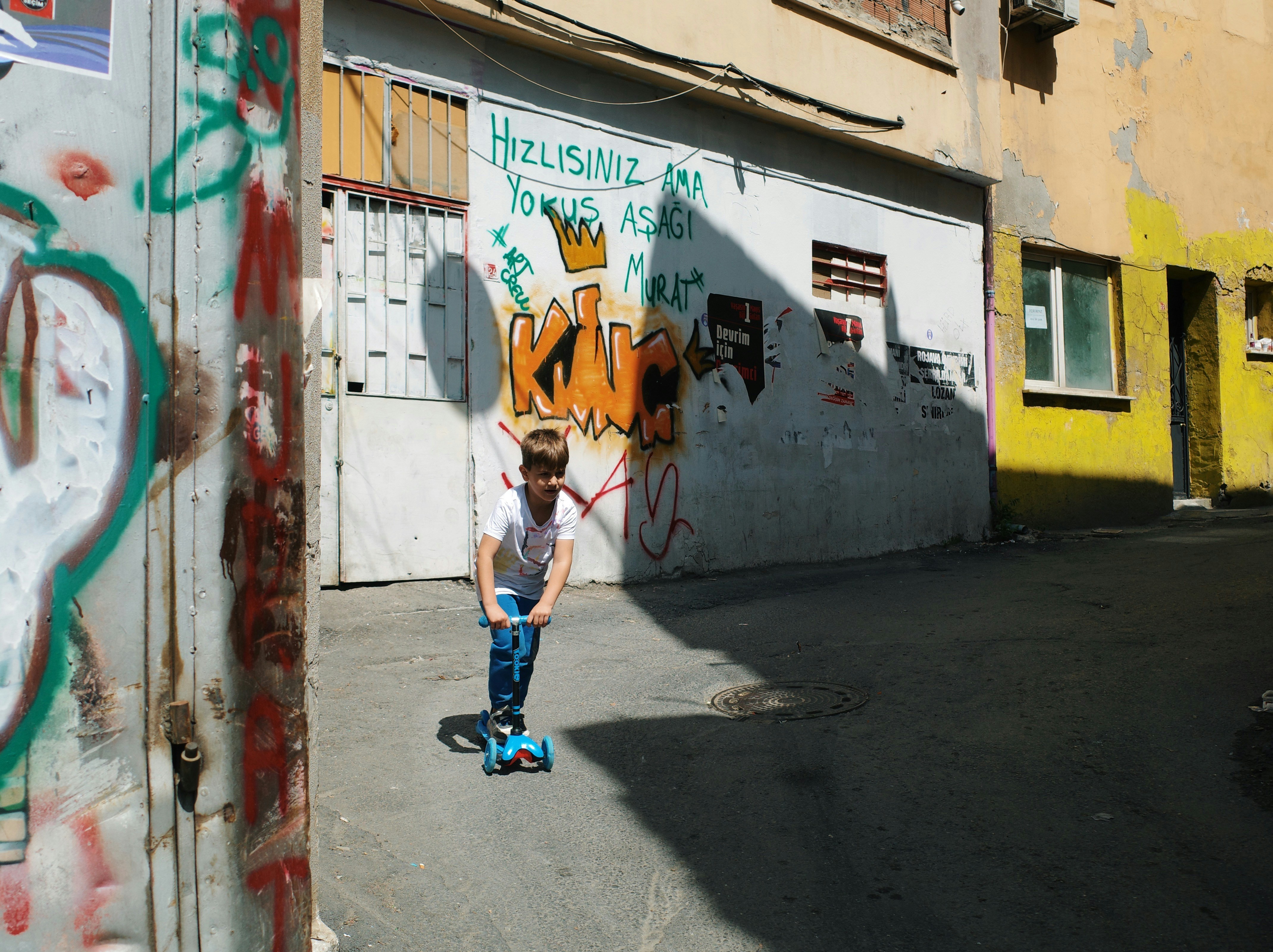 Skateboarder in a Graffiti Alley Under Bright Daylight