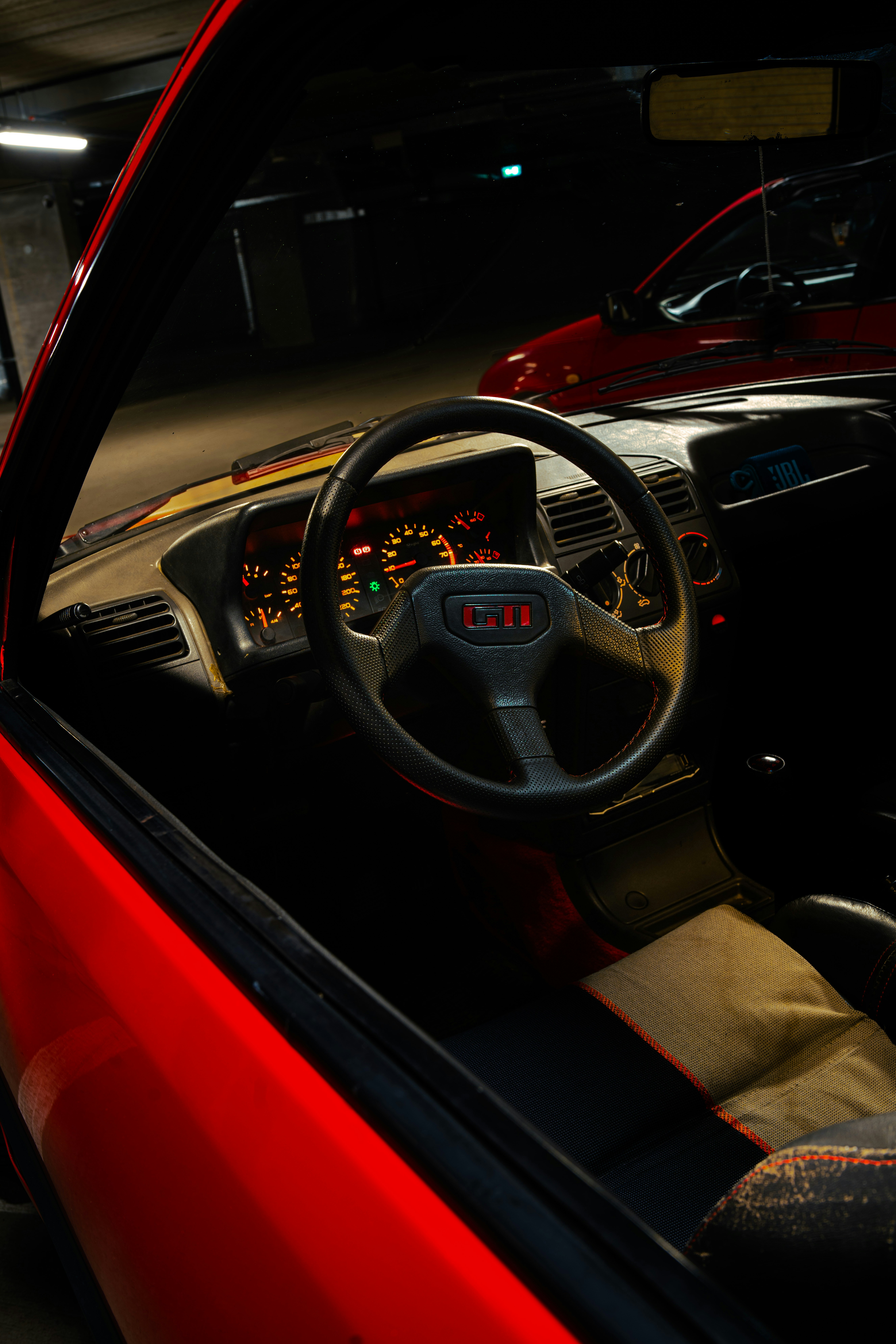 Red Cockpit Quietly Centered: A Night Drive Inside a Classic