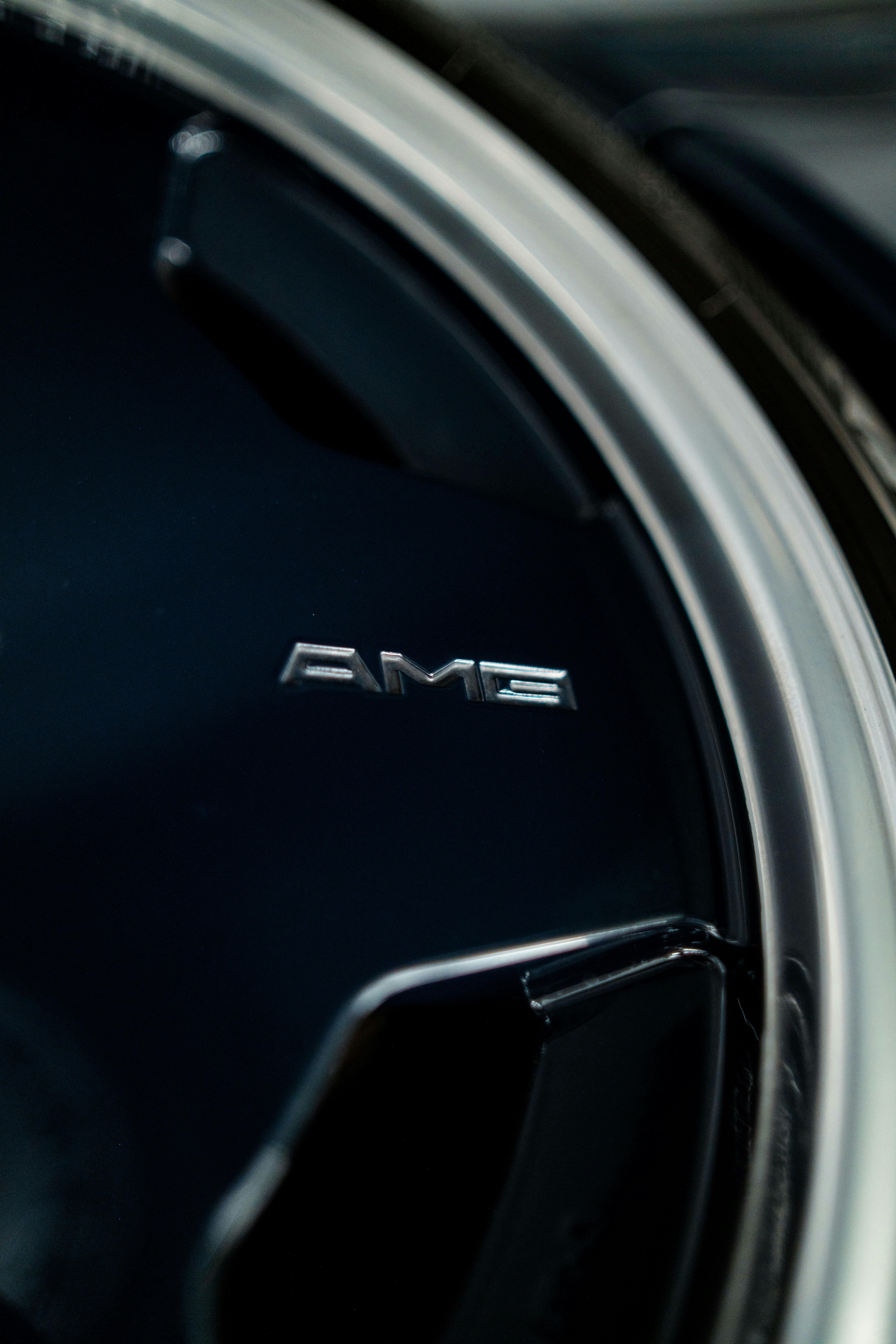 Close-up of a Mercedes AMG badge: precision and chrome under the ring