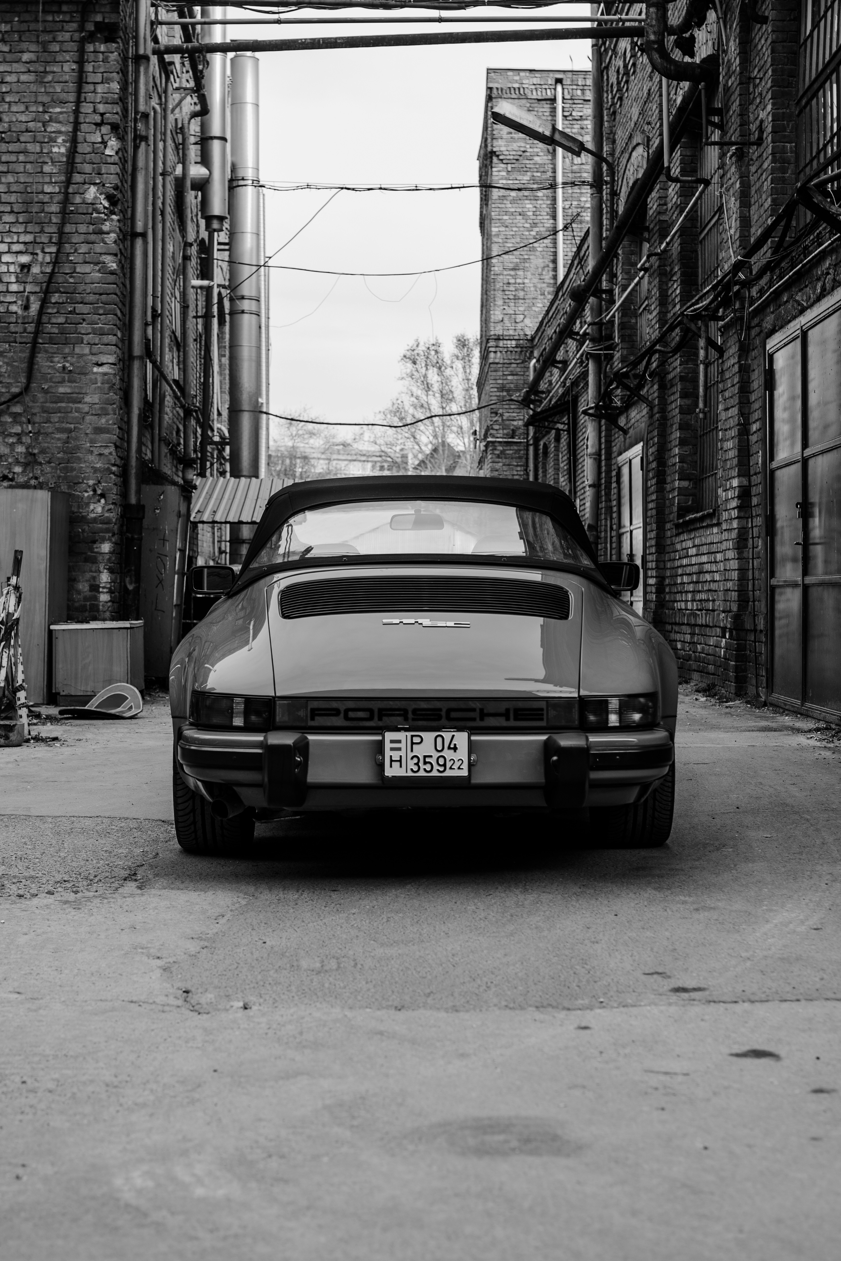 Rear-View of a Classic Porsche in an Urban Alleyway