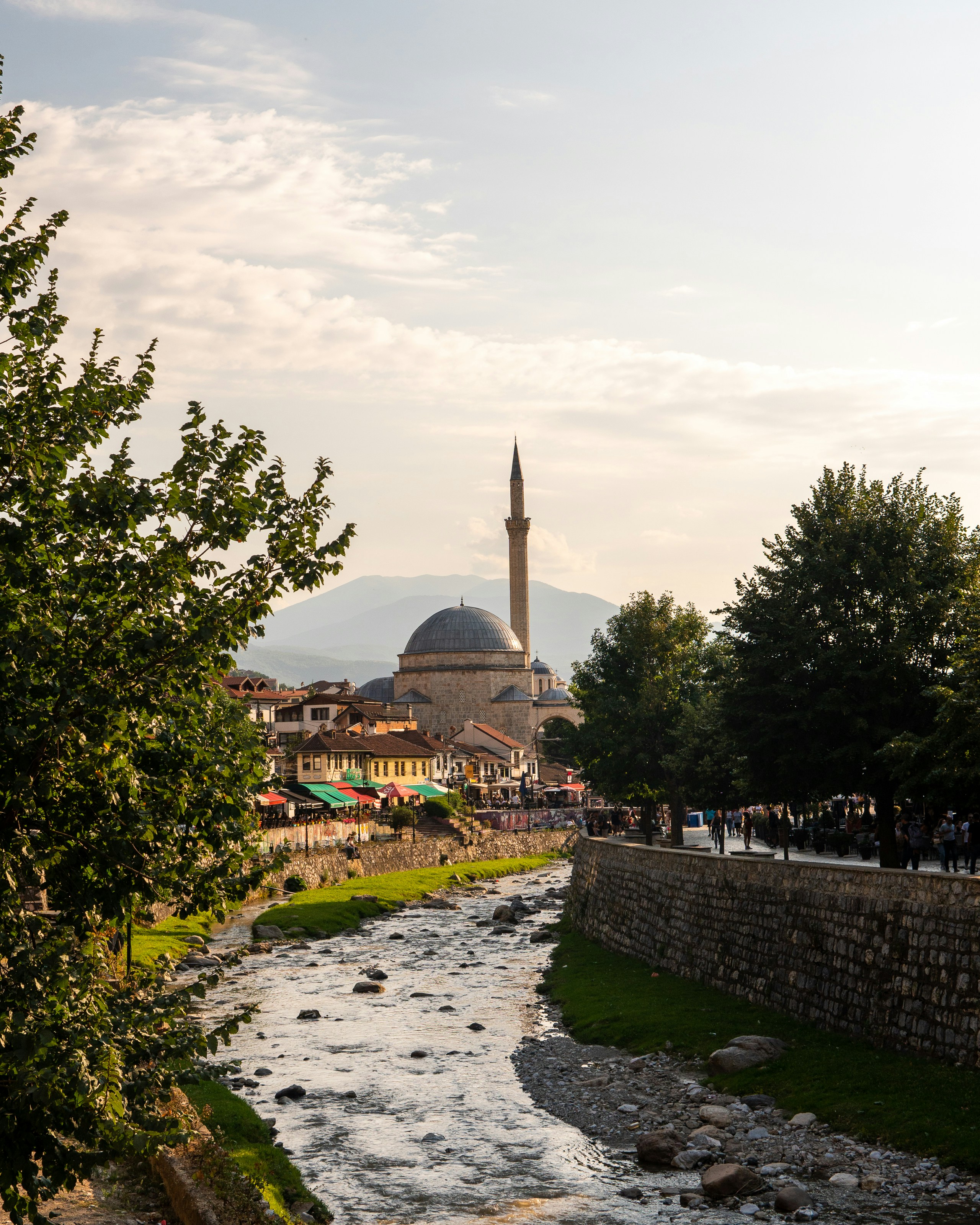 Riverfront Mosque and Market Under Soft Evening Light