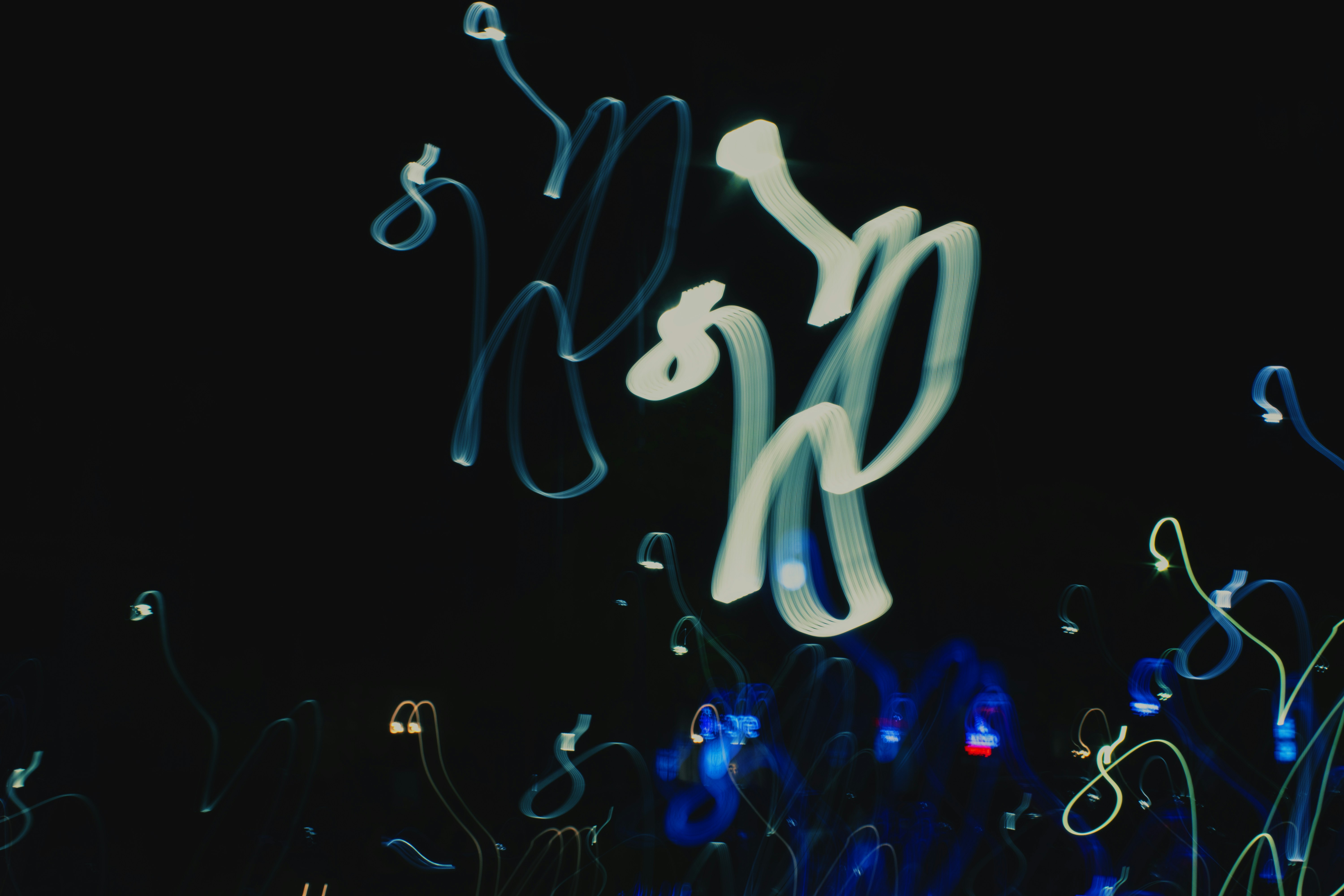 Neon Calligraphy in the Black: Abstract Light Trails in Motion