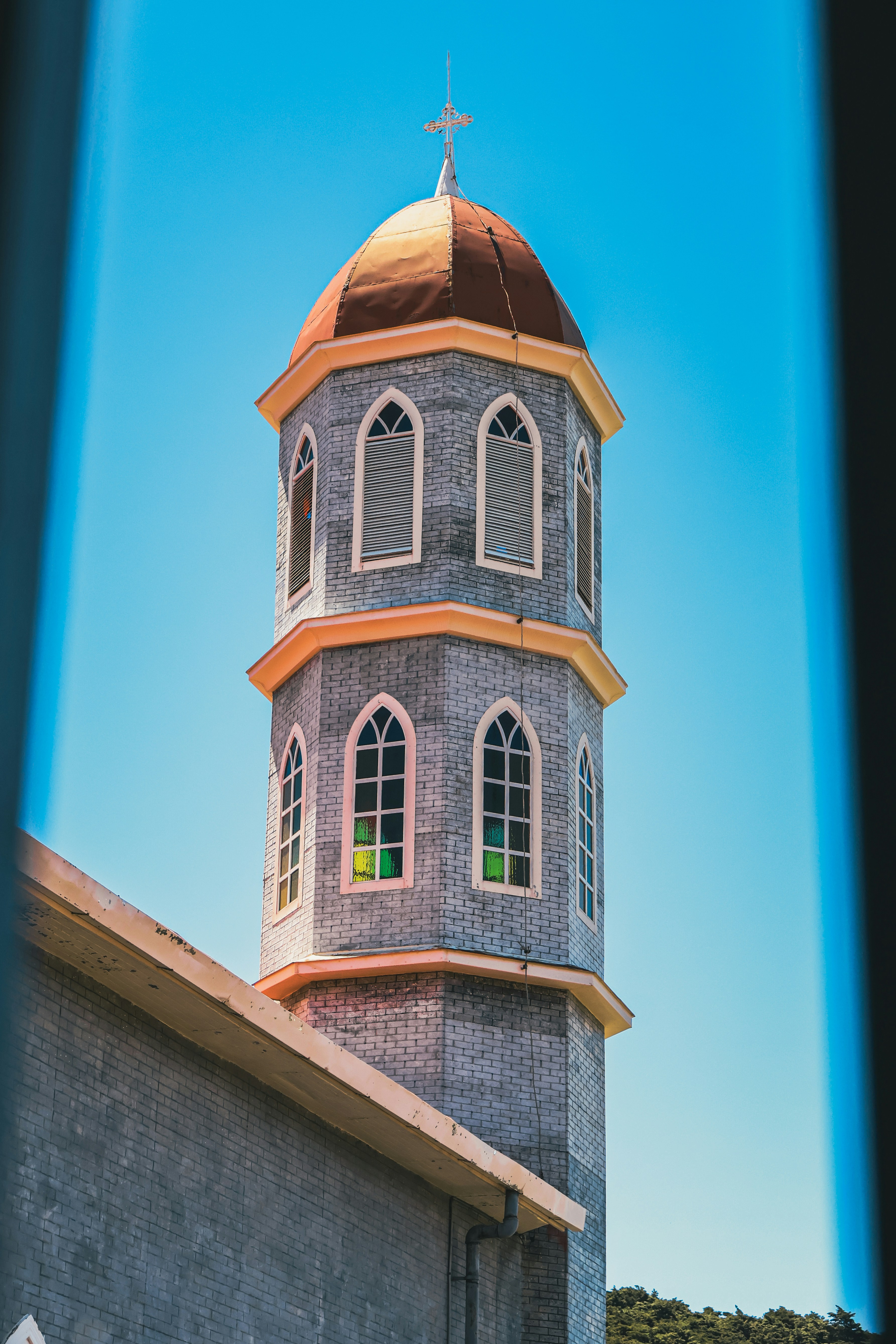 Towering Windowed Beacon: A Blue Sky Church Spire