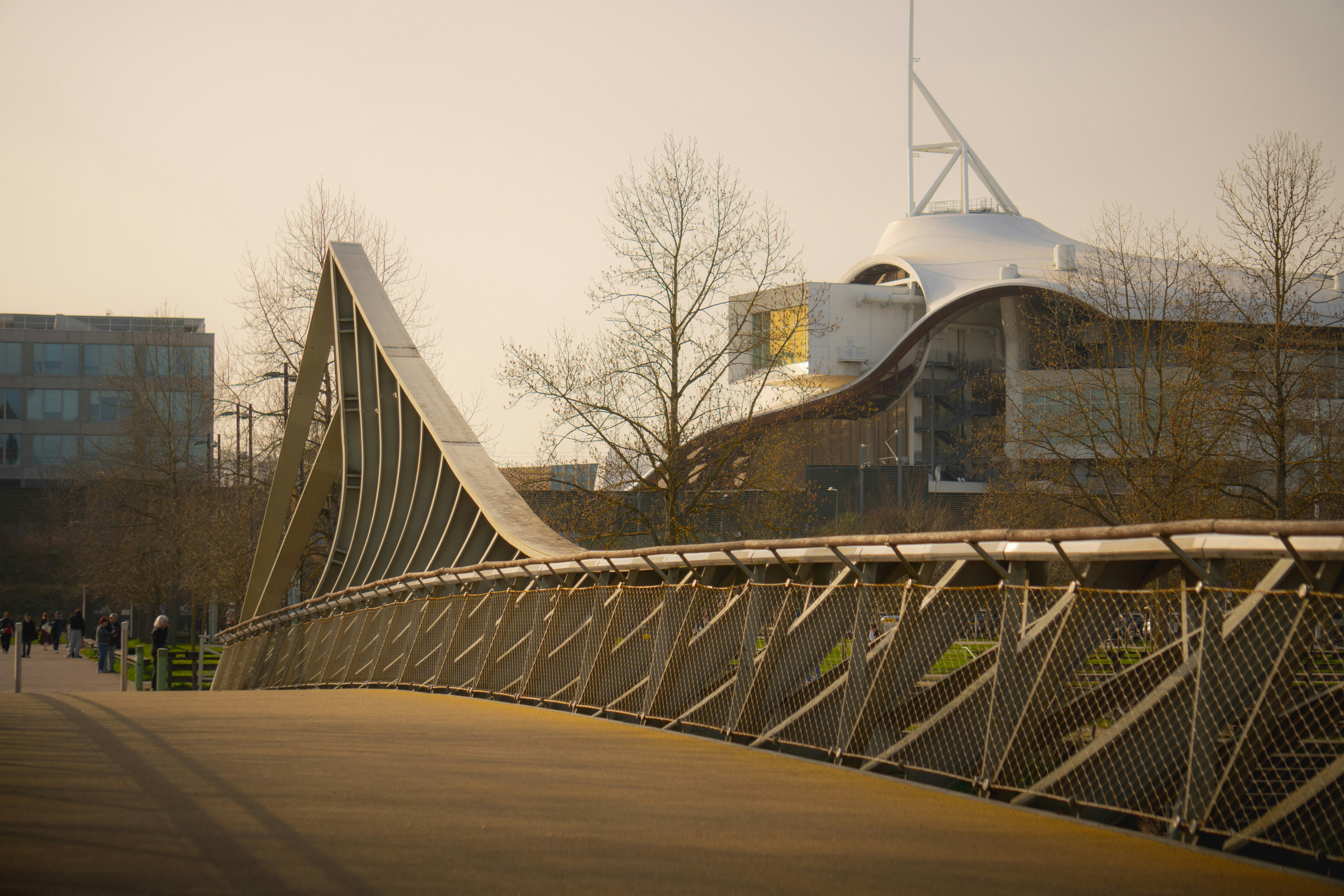 Curved Steel Arc: A Riverside Walkway and Wave-like Bridge