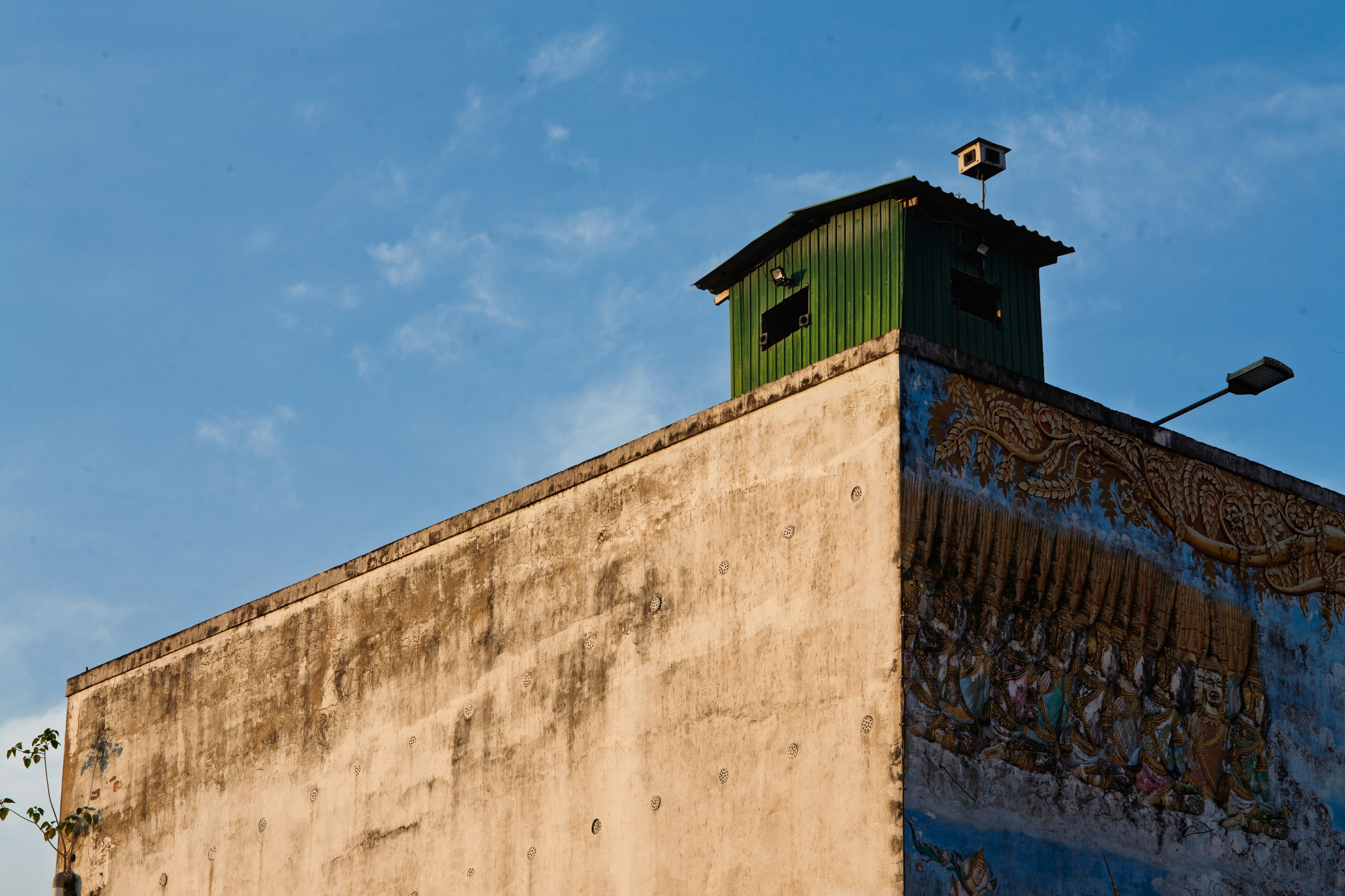 Green-Top Bell-Tower Above a Weathered Wall