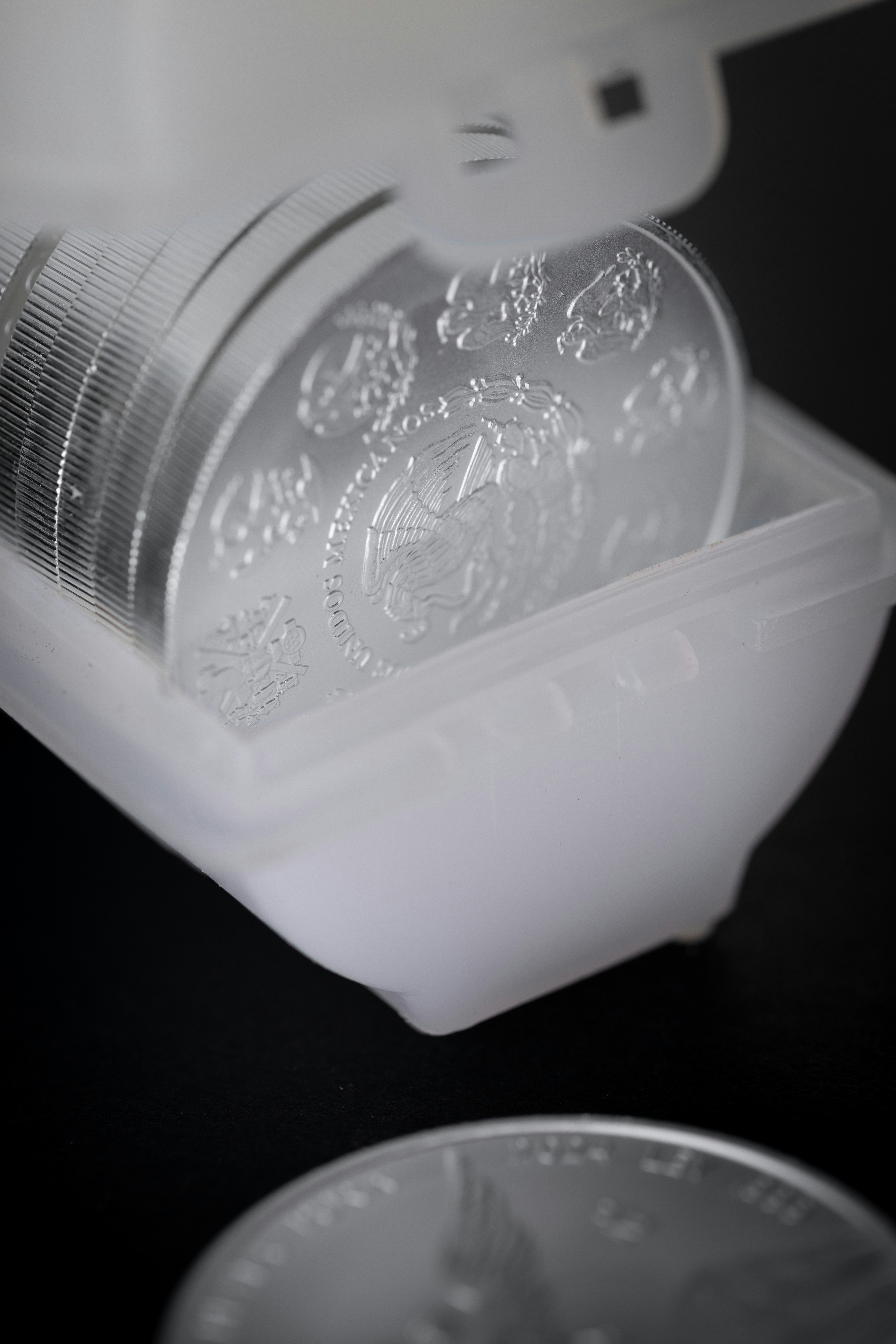 Shining Proof: A Close-Up of a Coin Drop in a Transparent Case