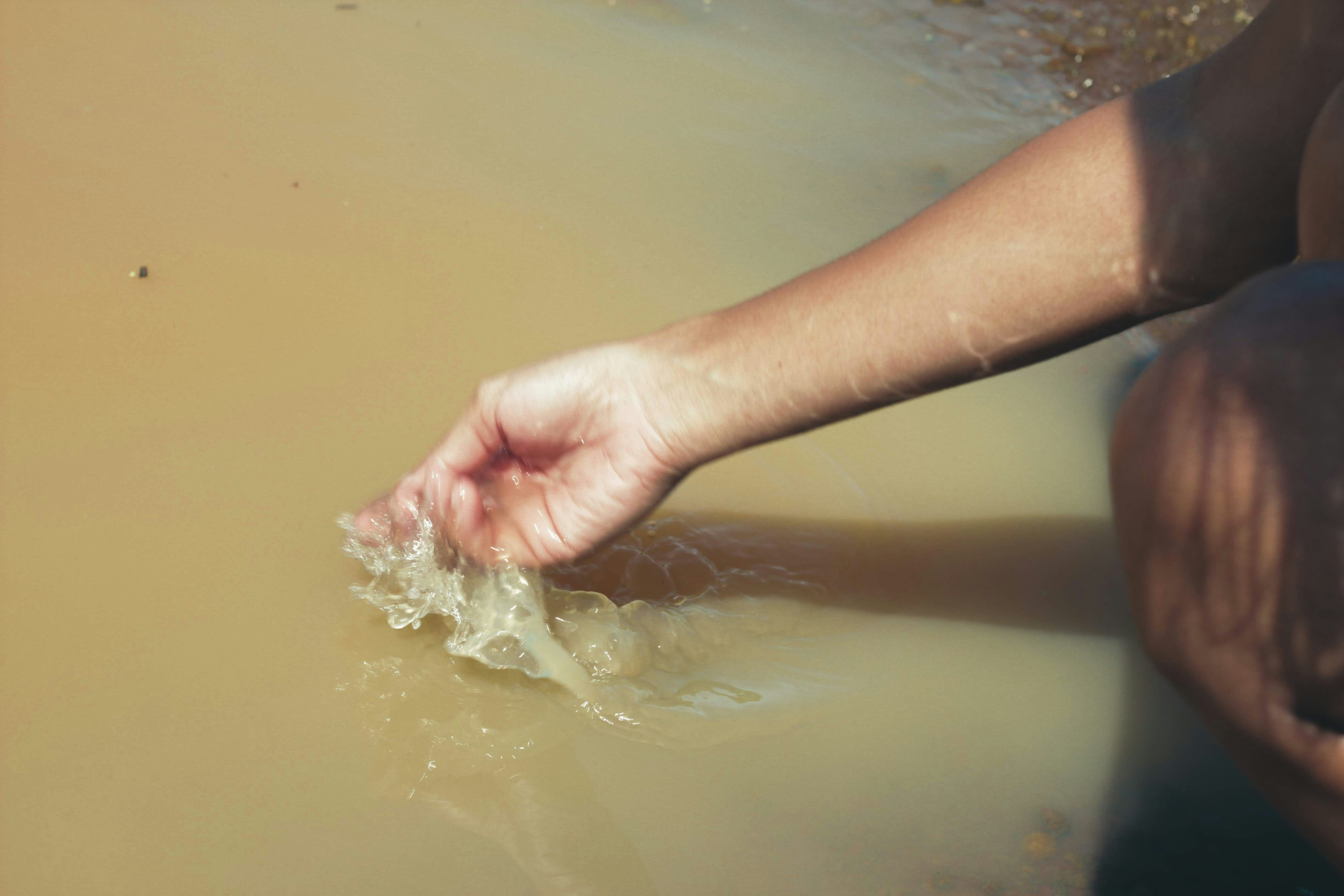 Hands in Mud: Quiet Moment by the Water