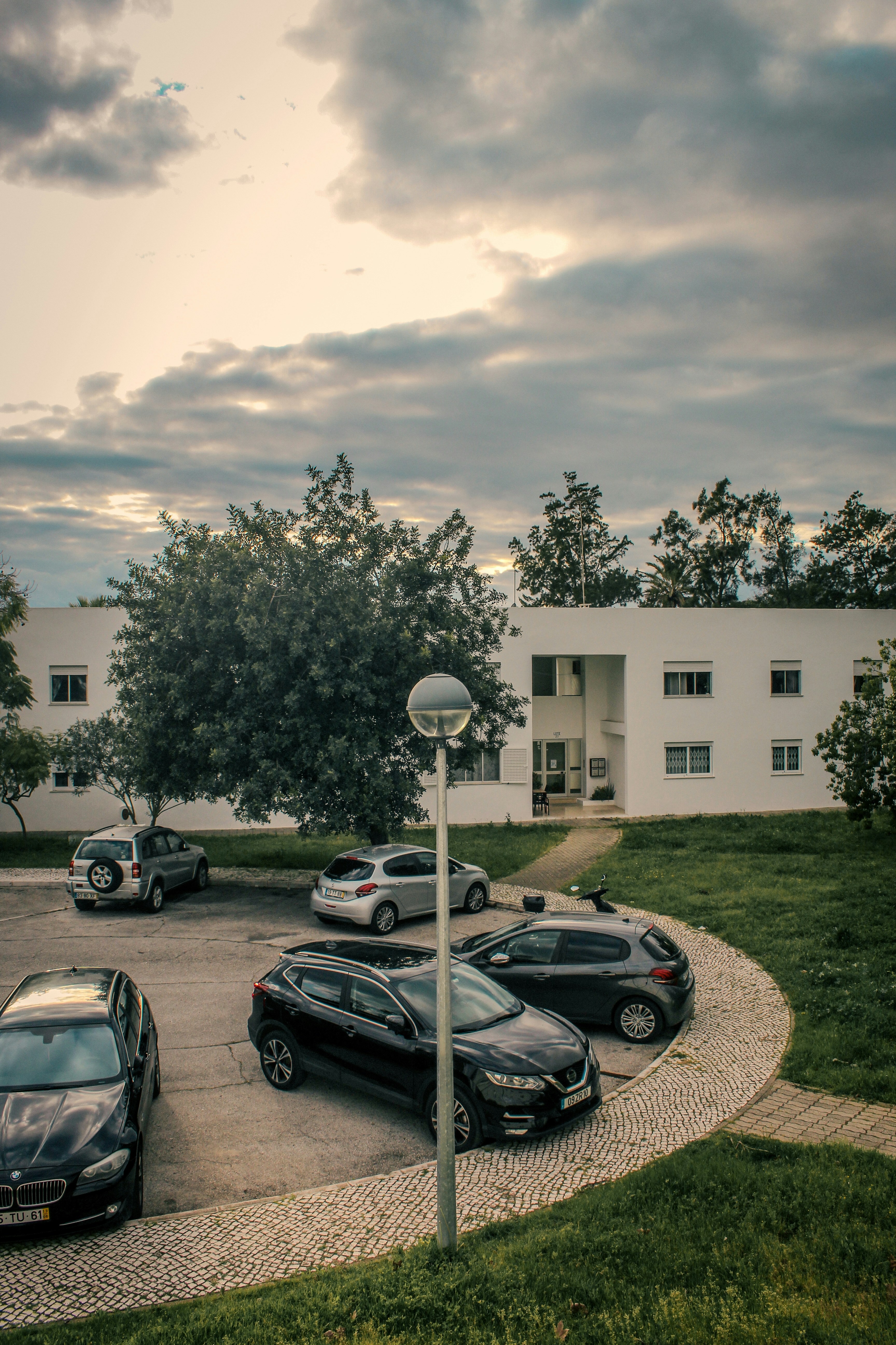 Parking Lot at Twilight: A Quiet Courtyard Beneath a Skies of Soft Clouds