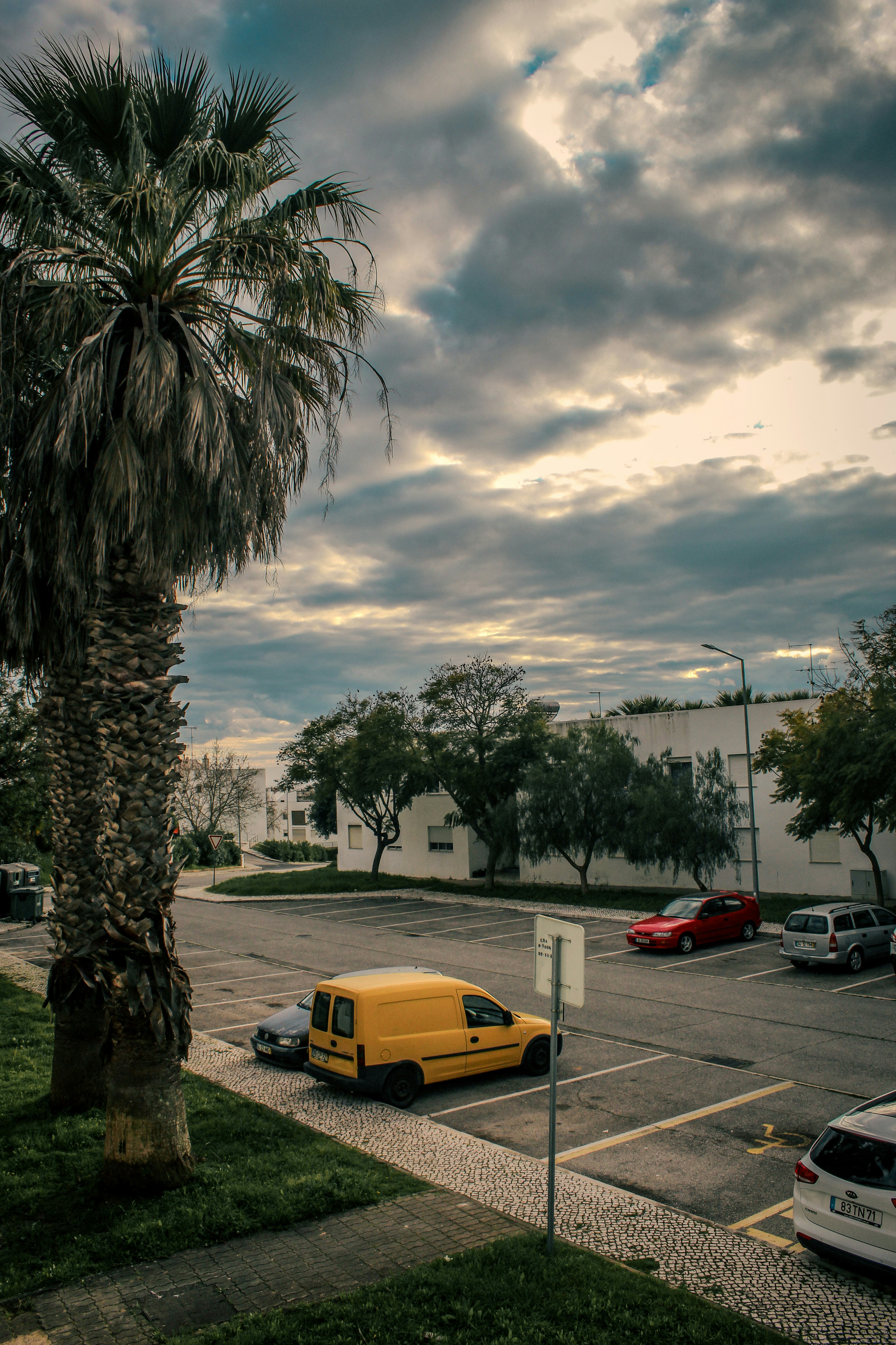 Orange Van in a Quiet Parking Lot Under Dramatic Sky