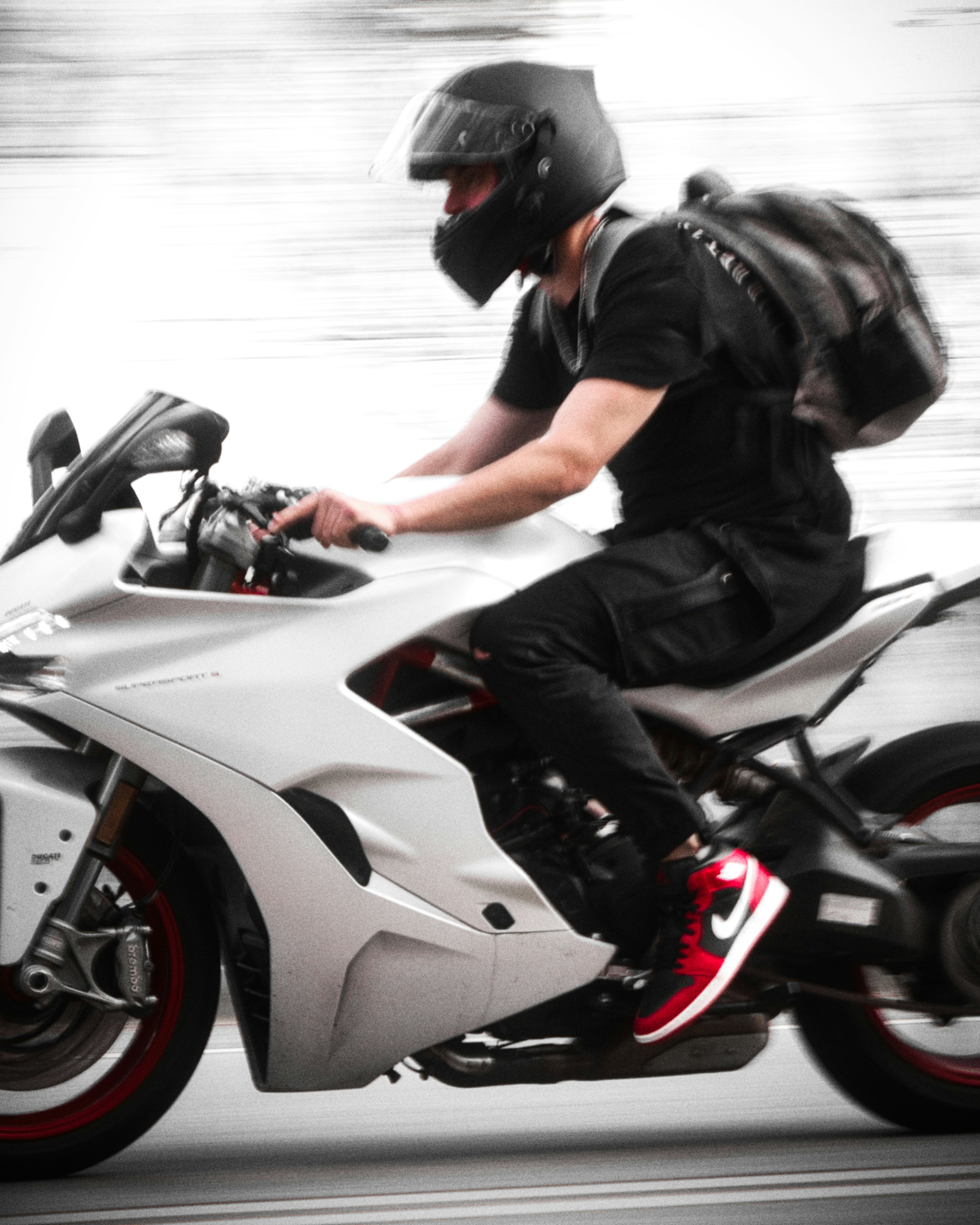 Blurring Speed: Rider in Focus Amid Hushed Motion