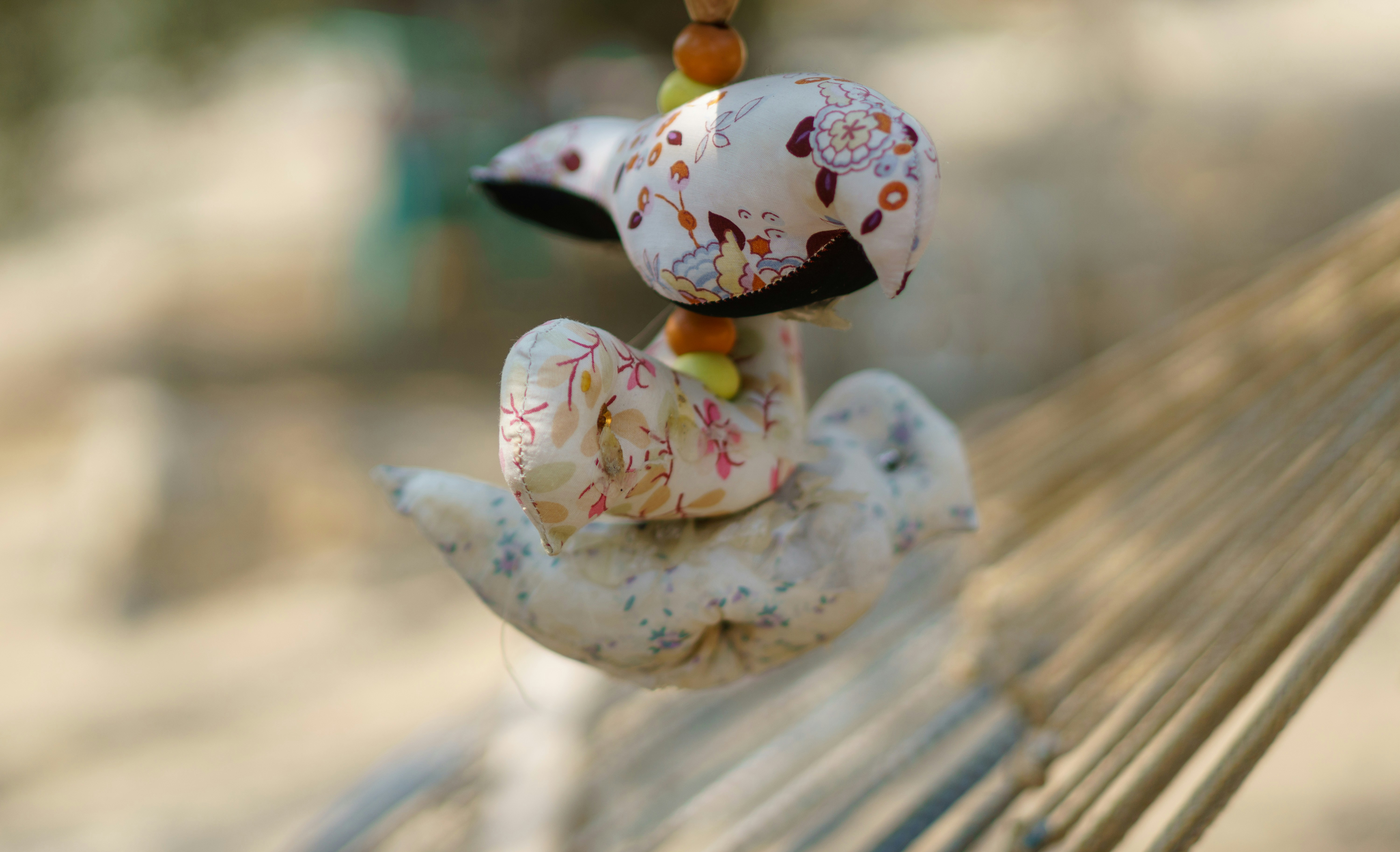 Floating fabric birds on a sunlit railing