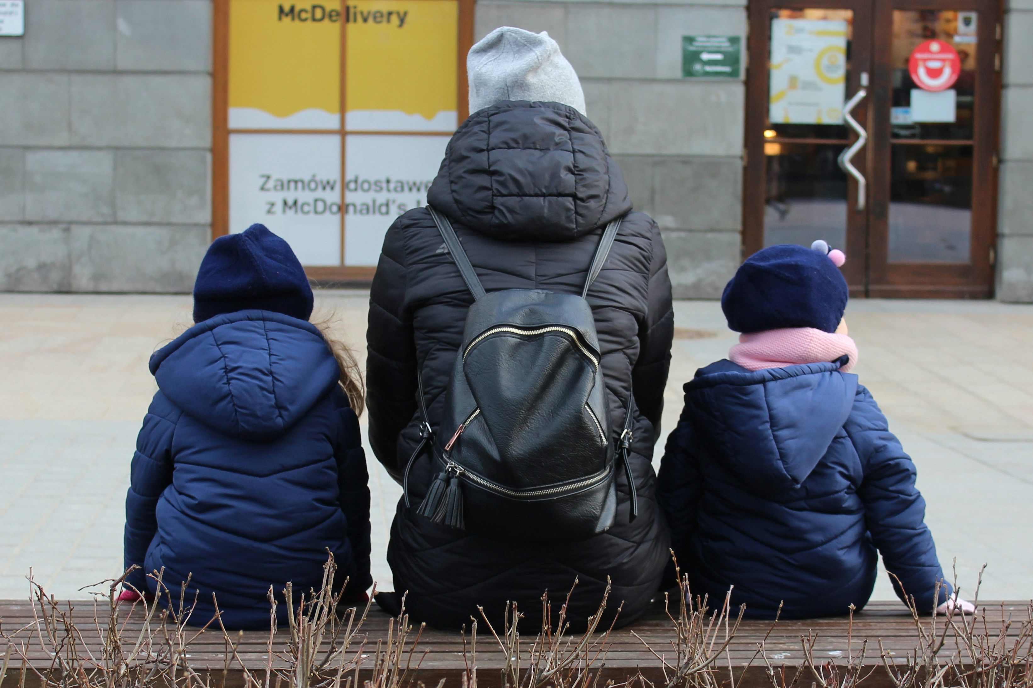 Trio on a Bench: Winter Outsides, Back View at a McDelivery
