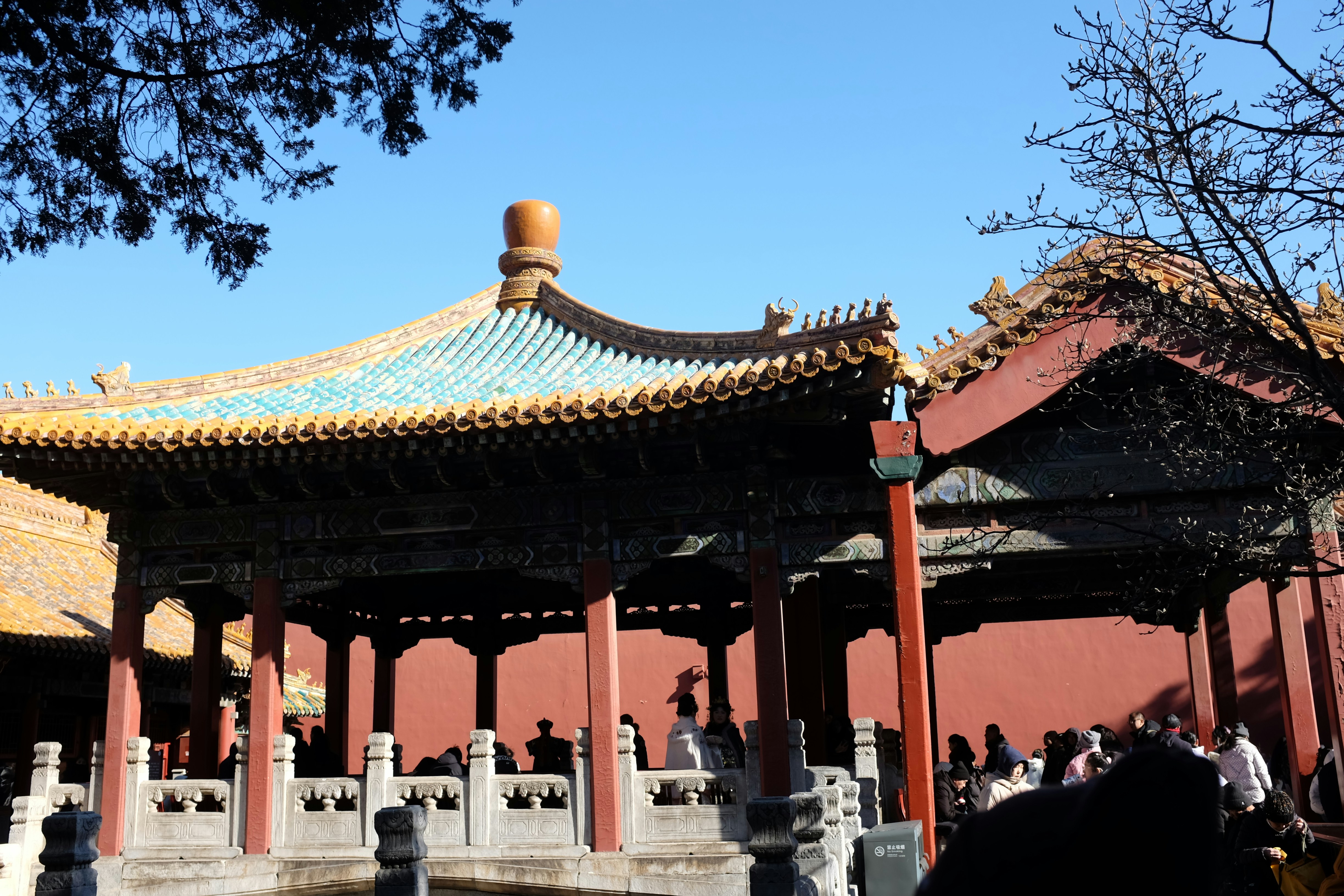 Traditional chinese architecture with red walls and tiled roof.