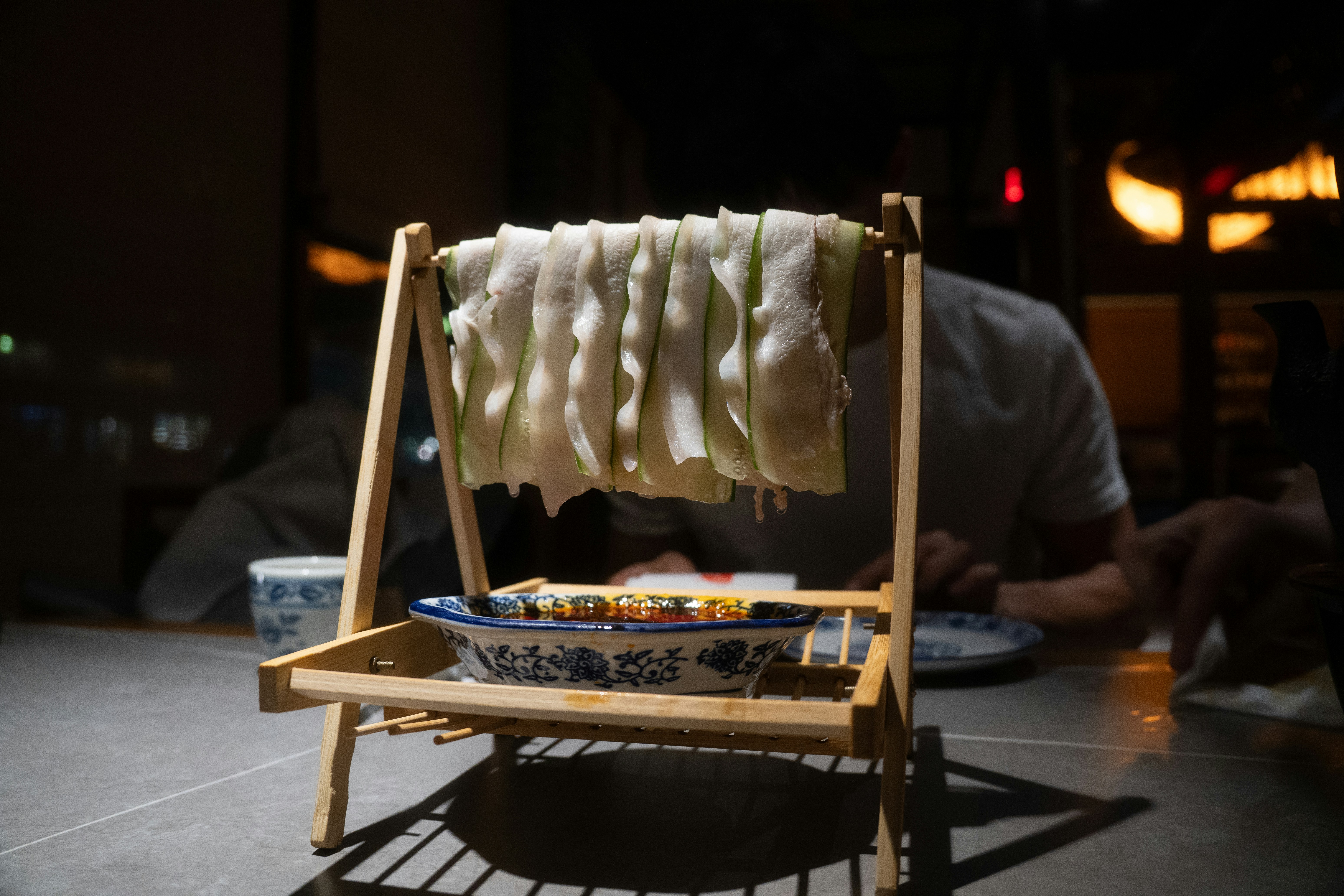 Dumplings on a Wooden Rack: Quiet Indulgence in a Dimly Lit Eatery