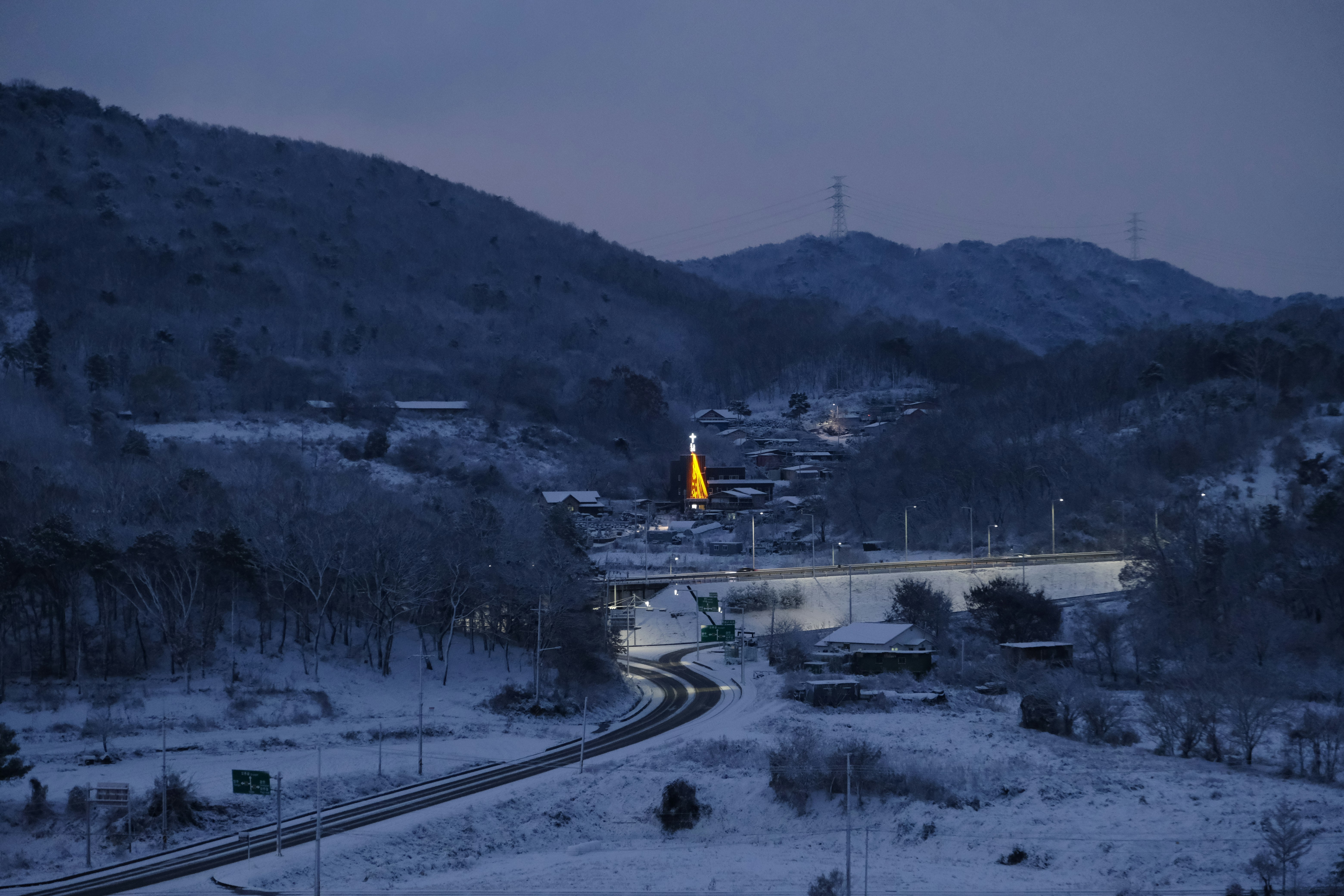 A Lone Sentinel Illuminates Snow-Capped Valley