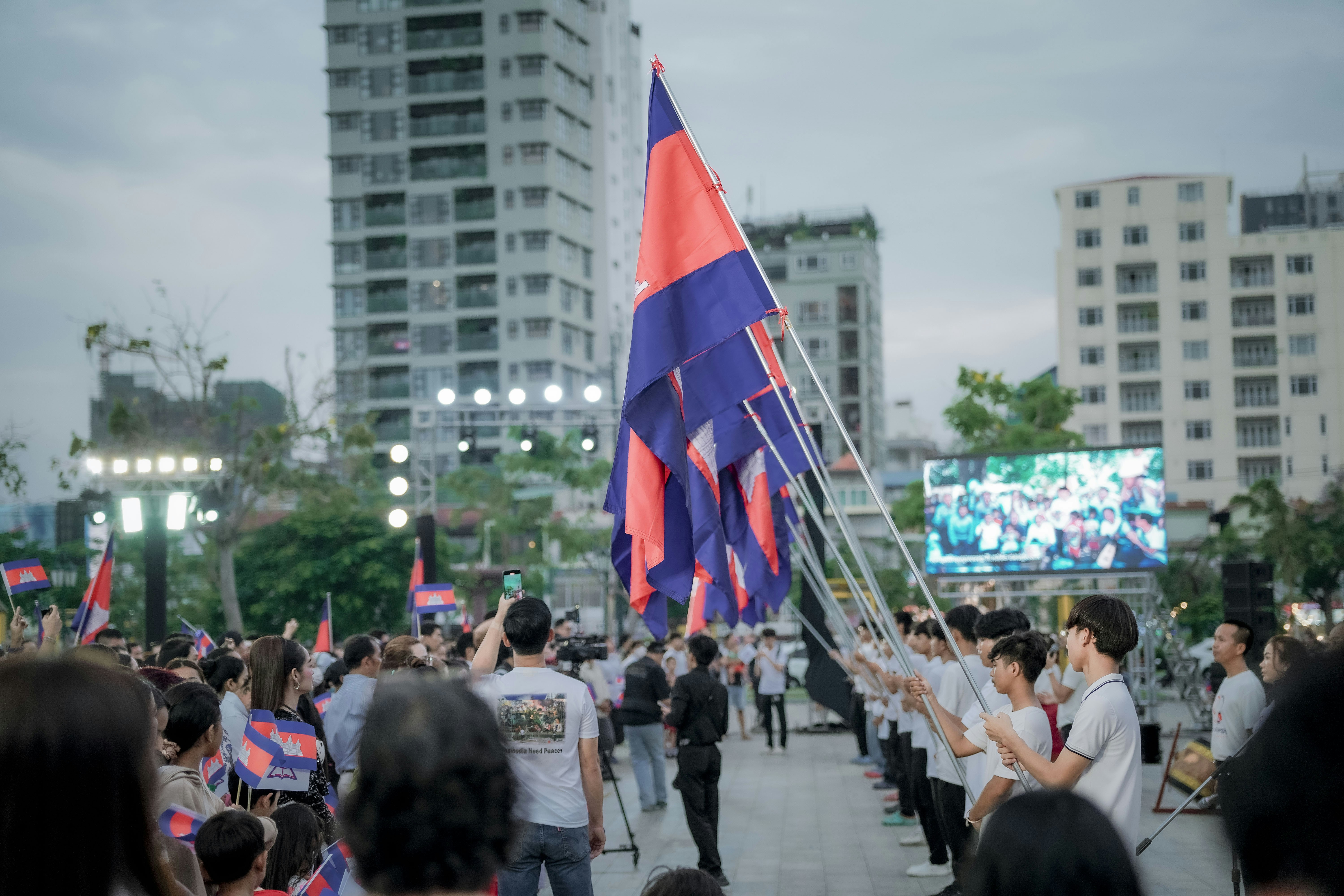 Flag ceremony amidst a cityscape rally