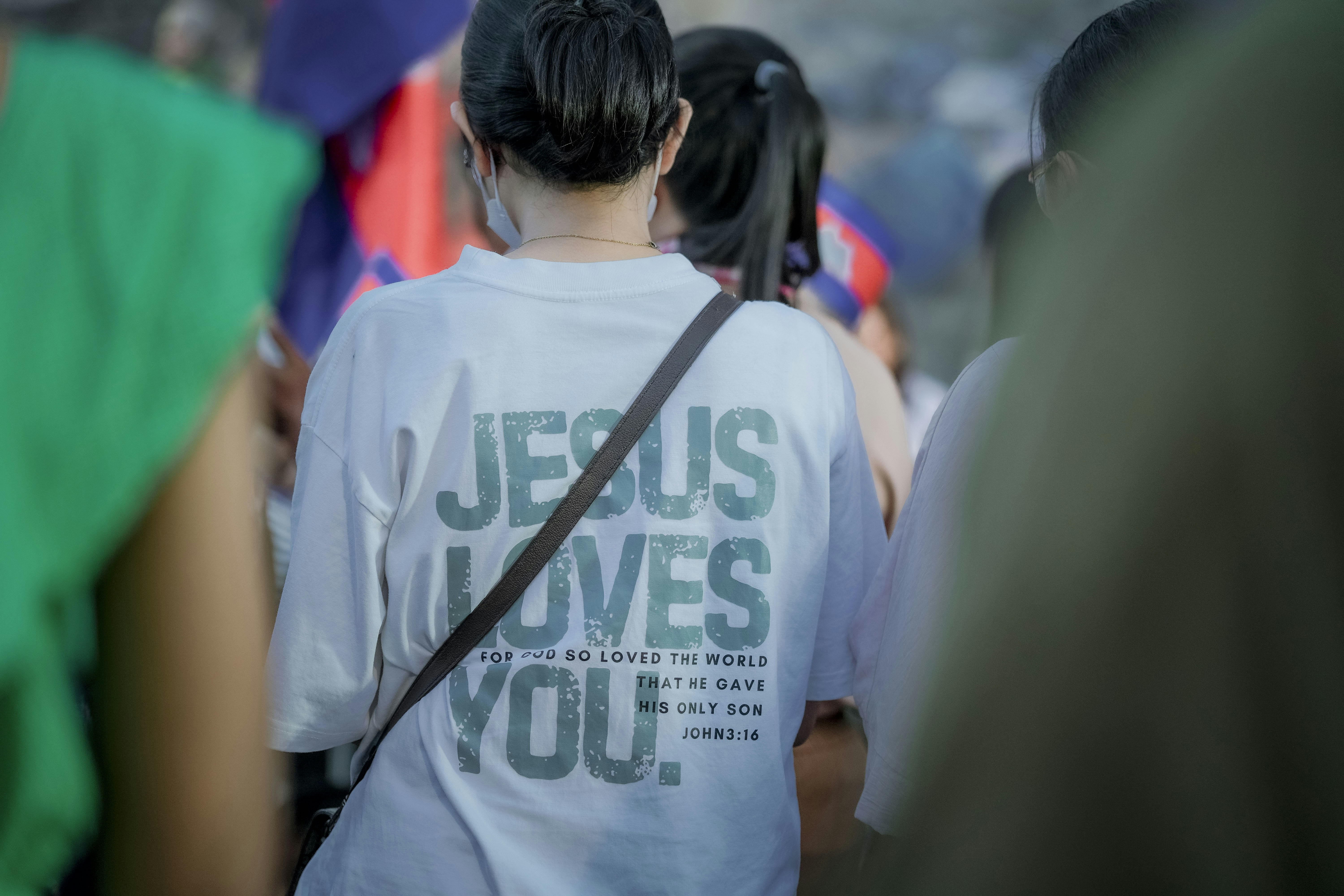 Backlit Message: A Crowd-Facing Tee Reads 'JESUS LOVES YOU'