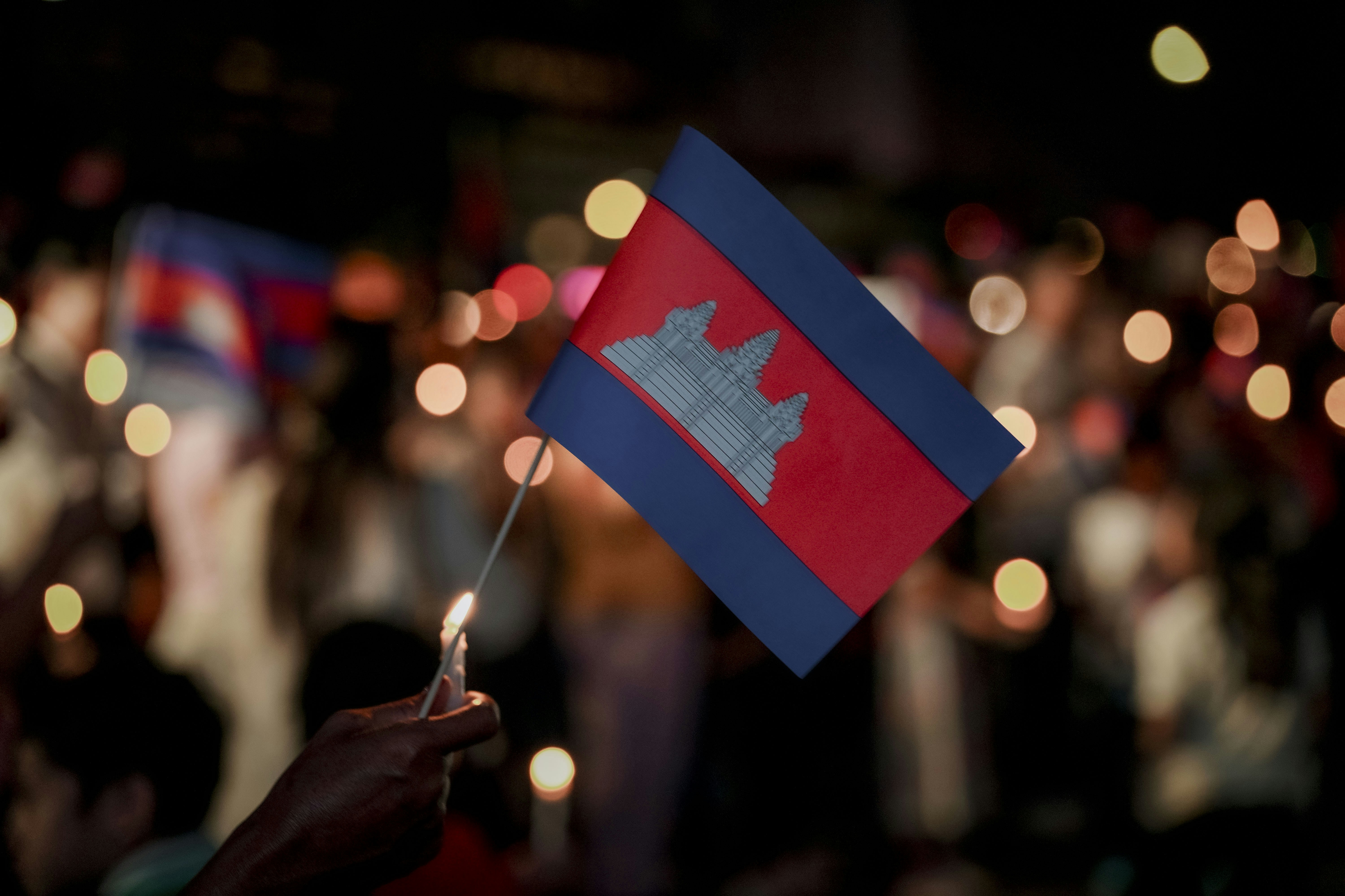 Candle-lit Flag Moment: A Cambodian Flag in a Night Rally