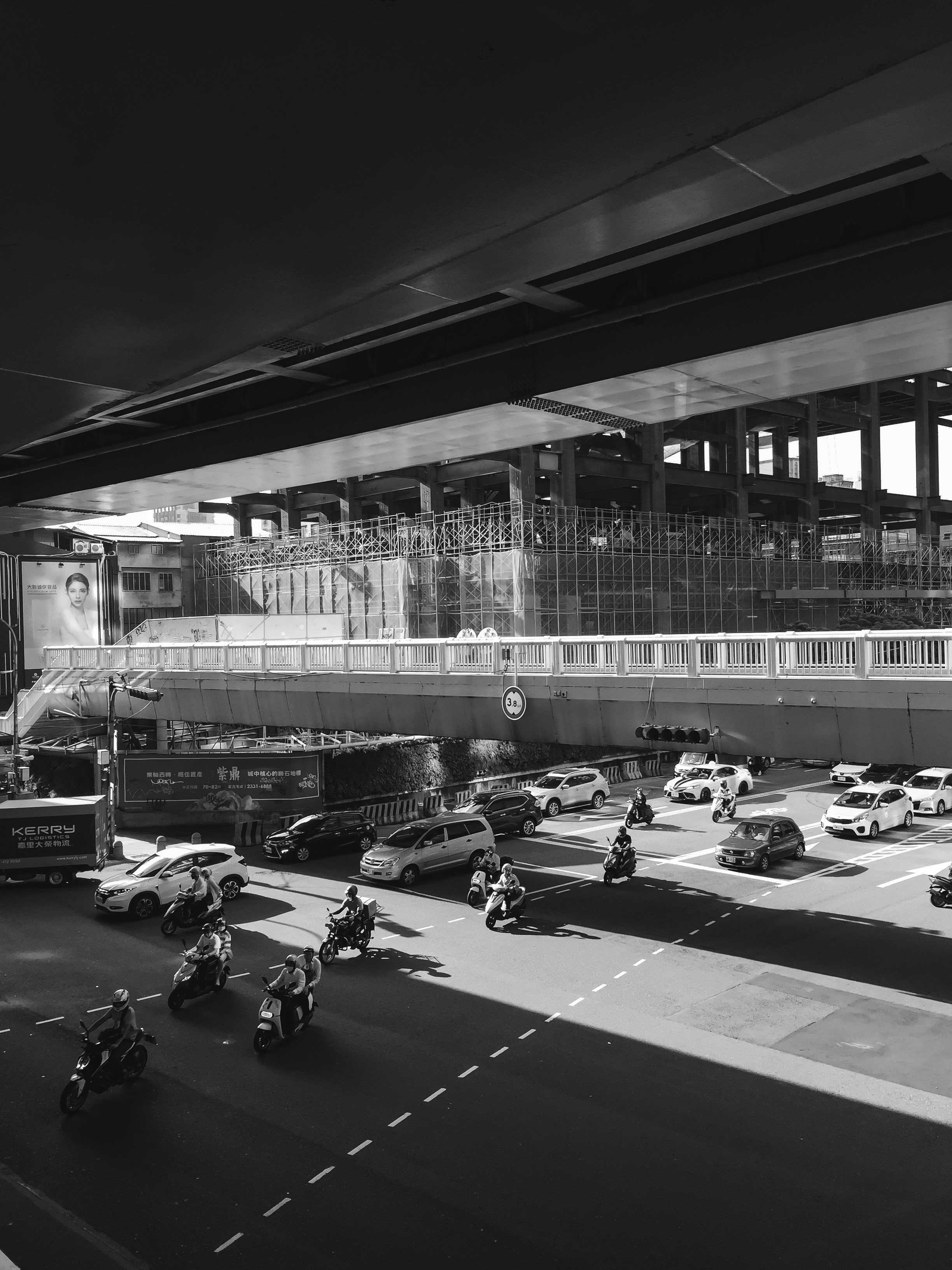 Urban Flow: Cars, Motorbikes, and a Subway Crossing in Steel and Shadow