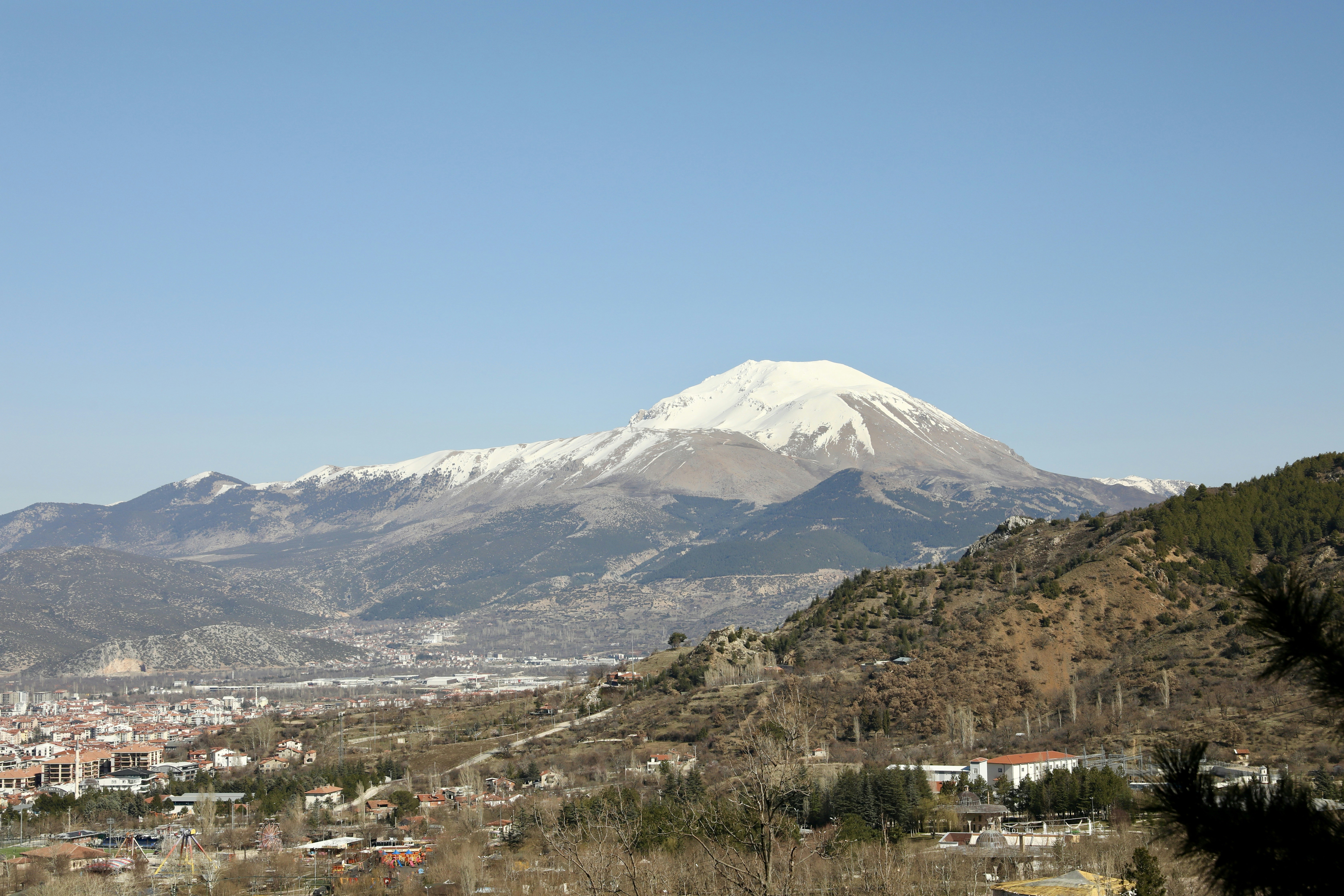 Snowcapped Peak Over a Quiet Valley Town