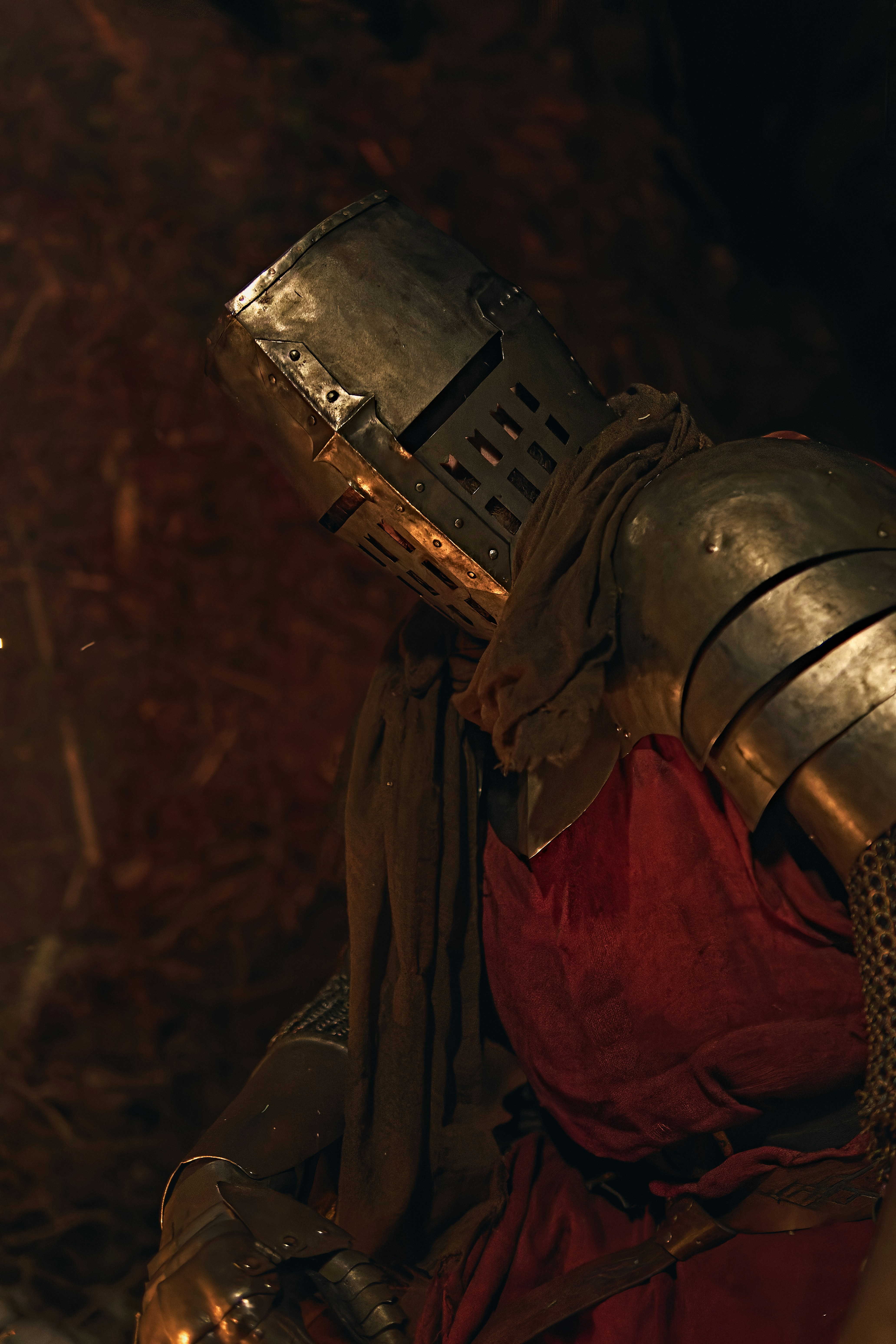 Knight in shadow: armor glints in a dusky dungeon