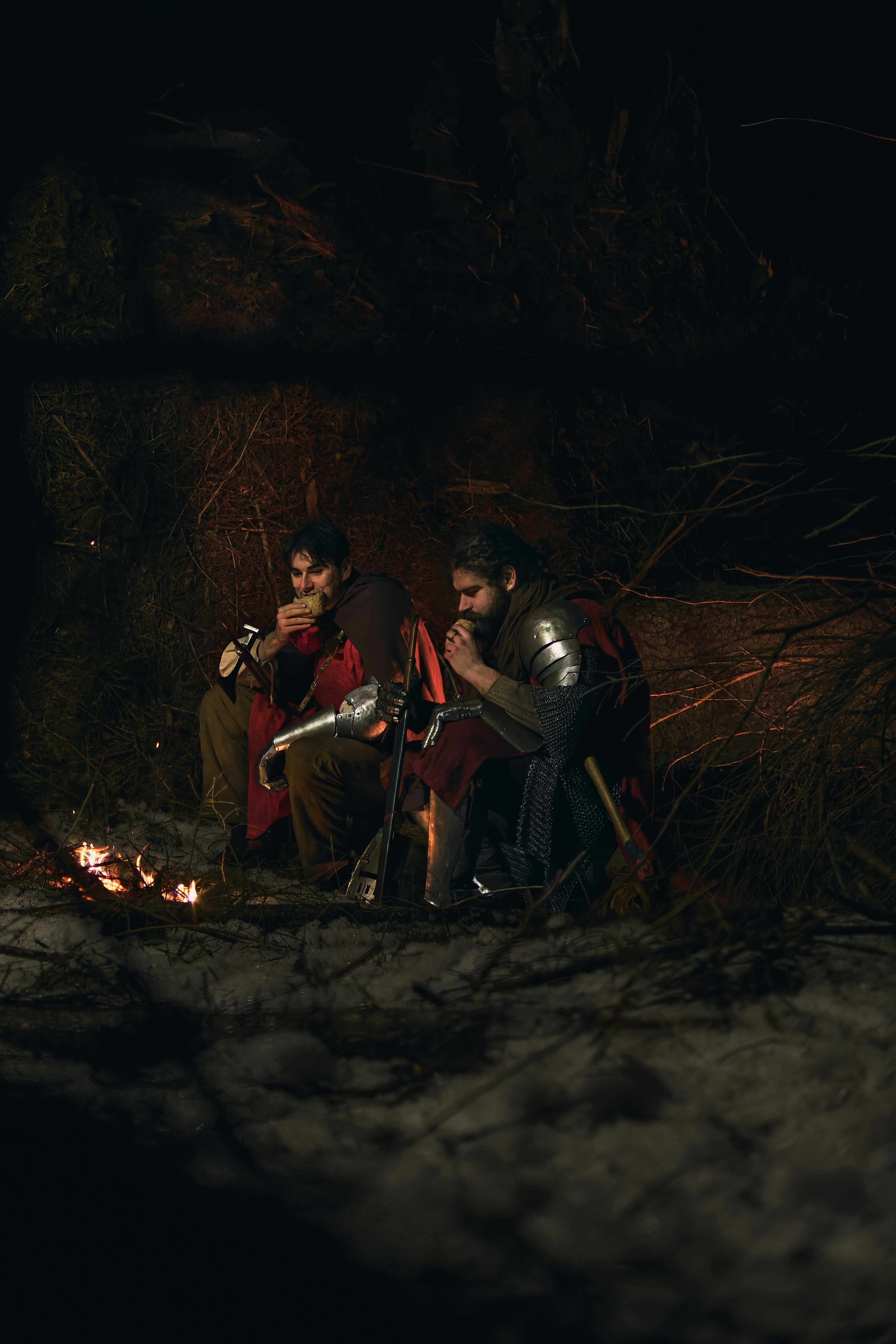 Nightfire in the forest: a trio of travelers by the embers