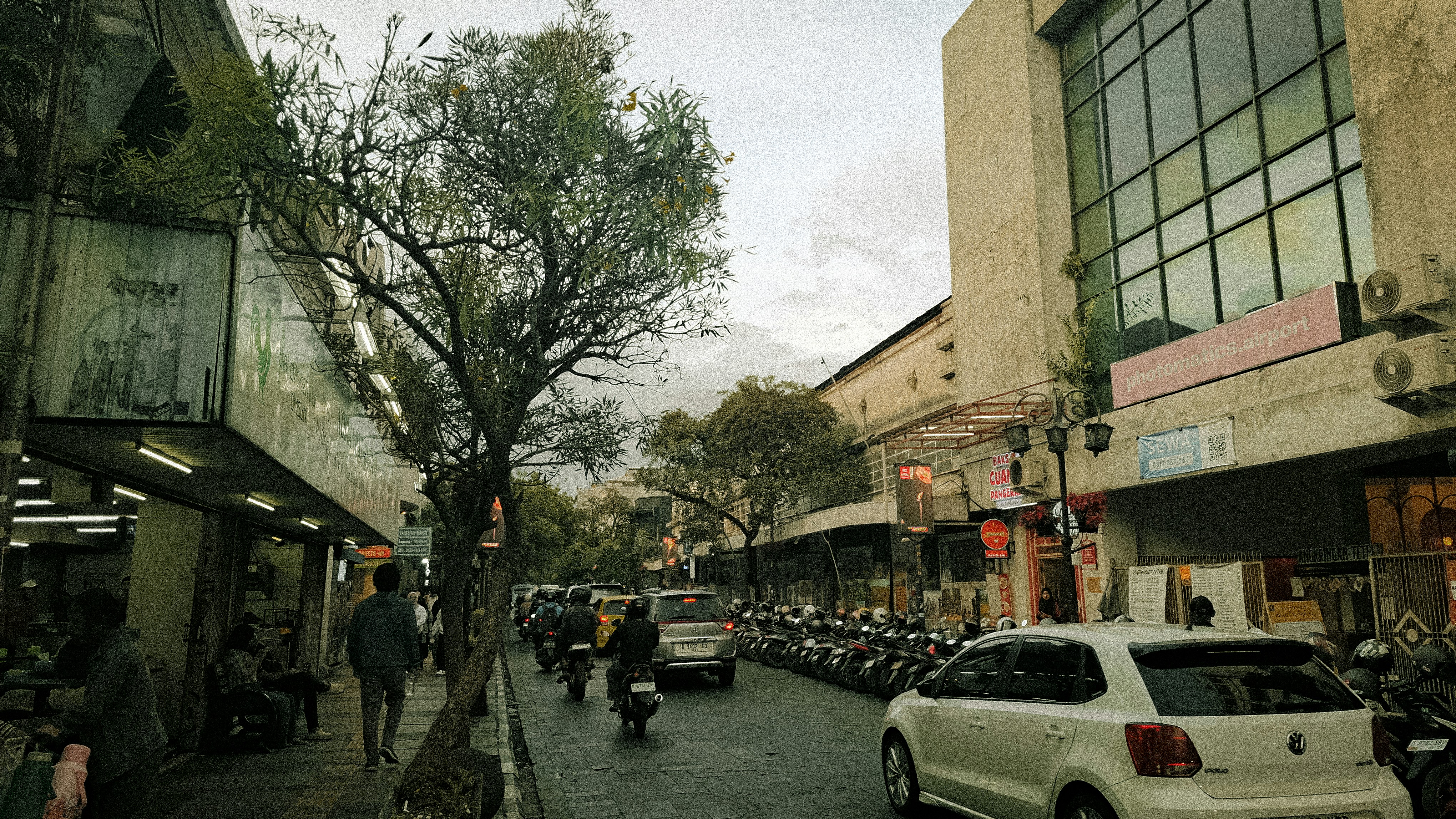 Street scene with traffic and parked motorcycles