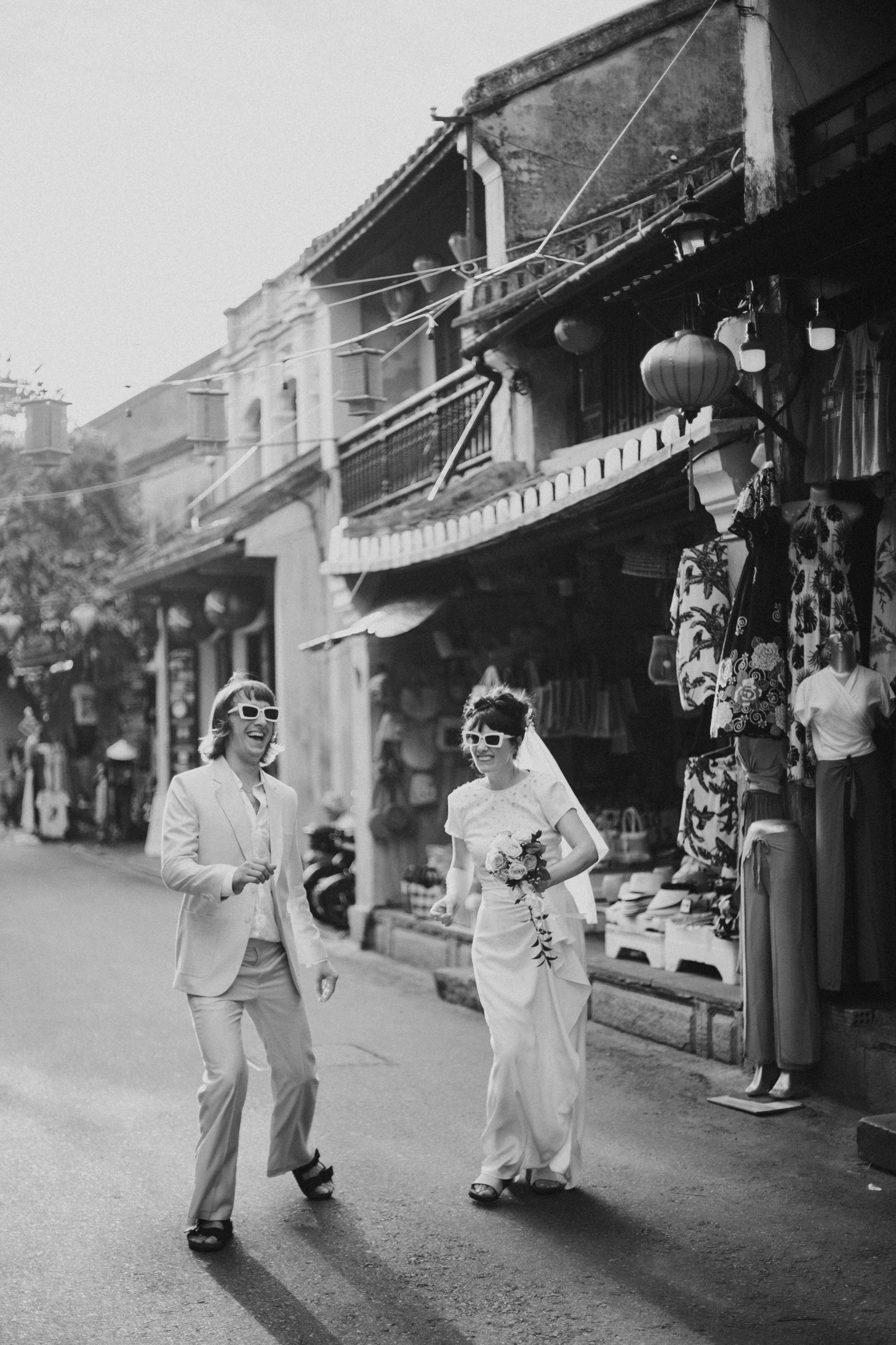 Bride-and-groom-turned-street-dancers in a grayscale wedding procession