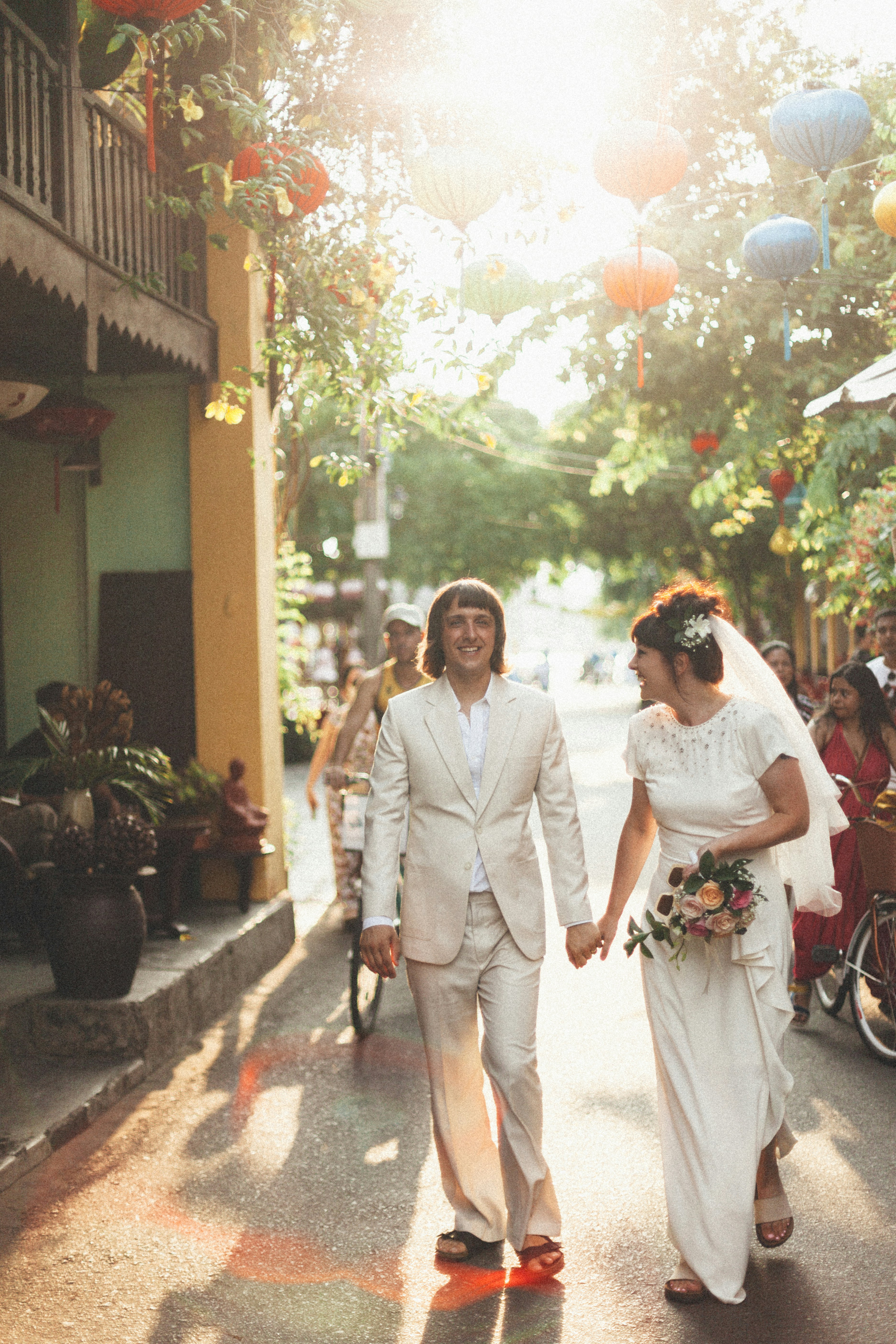 Sunlit Veil: A Newlywed Walk Through a Lantern-Lit Street