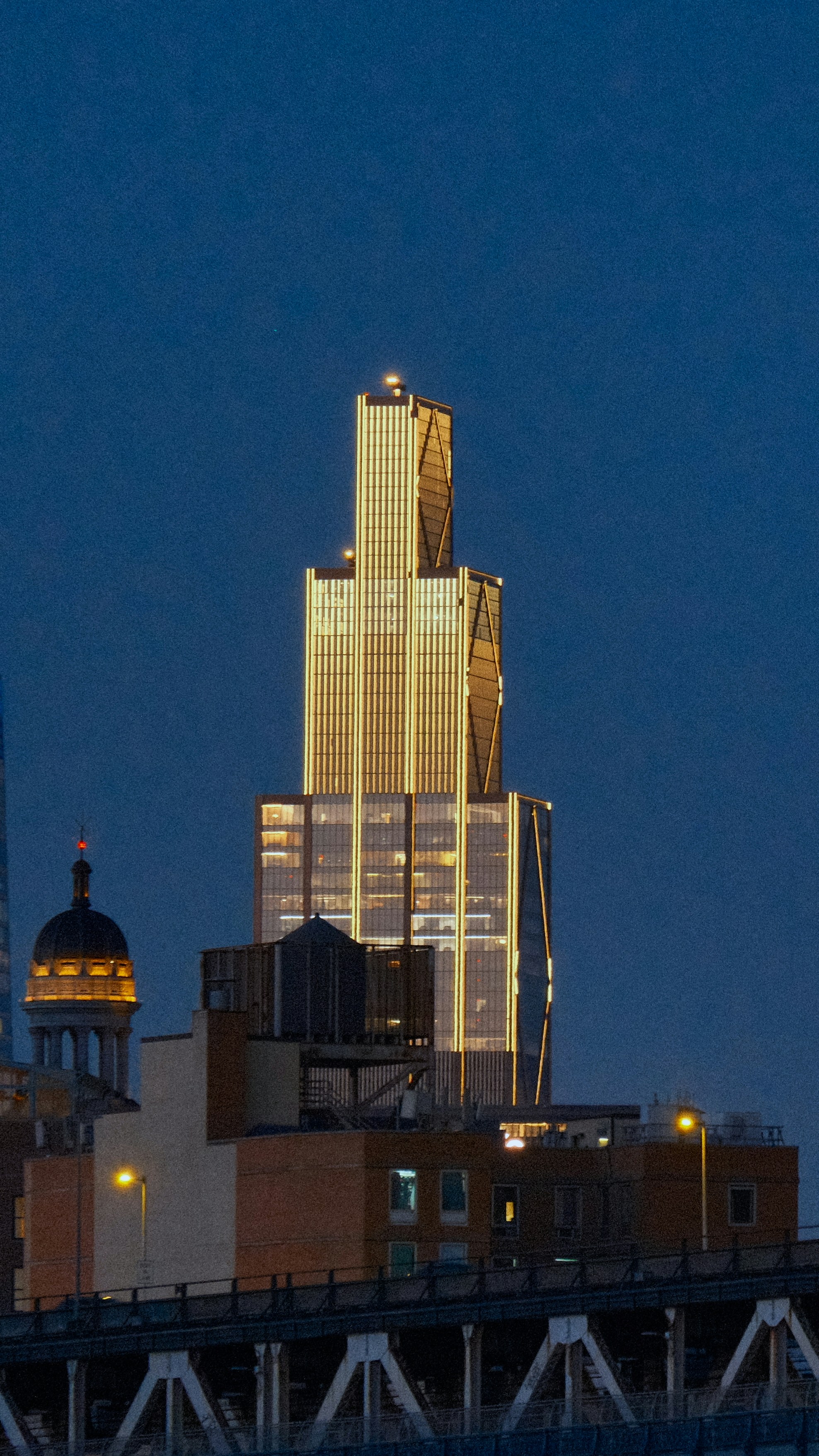 Skyline Tower: Golden Facades Rising Over a Dusk Street