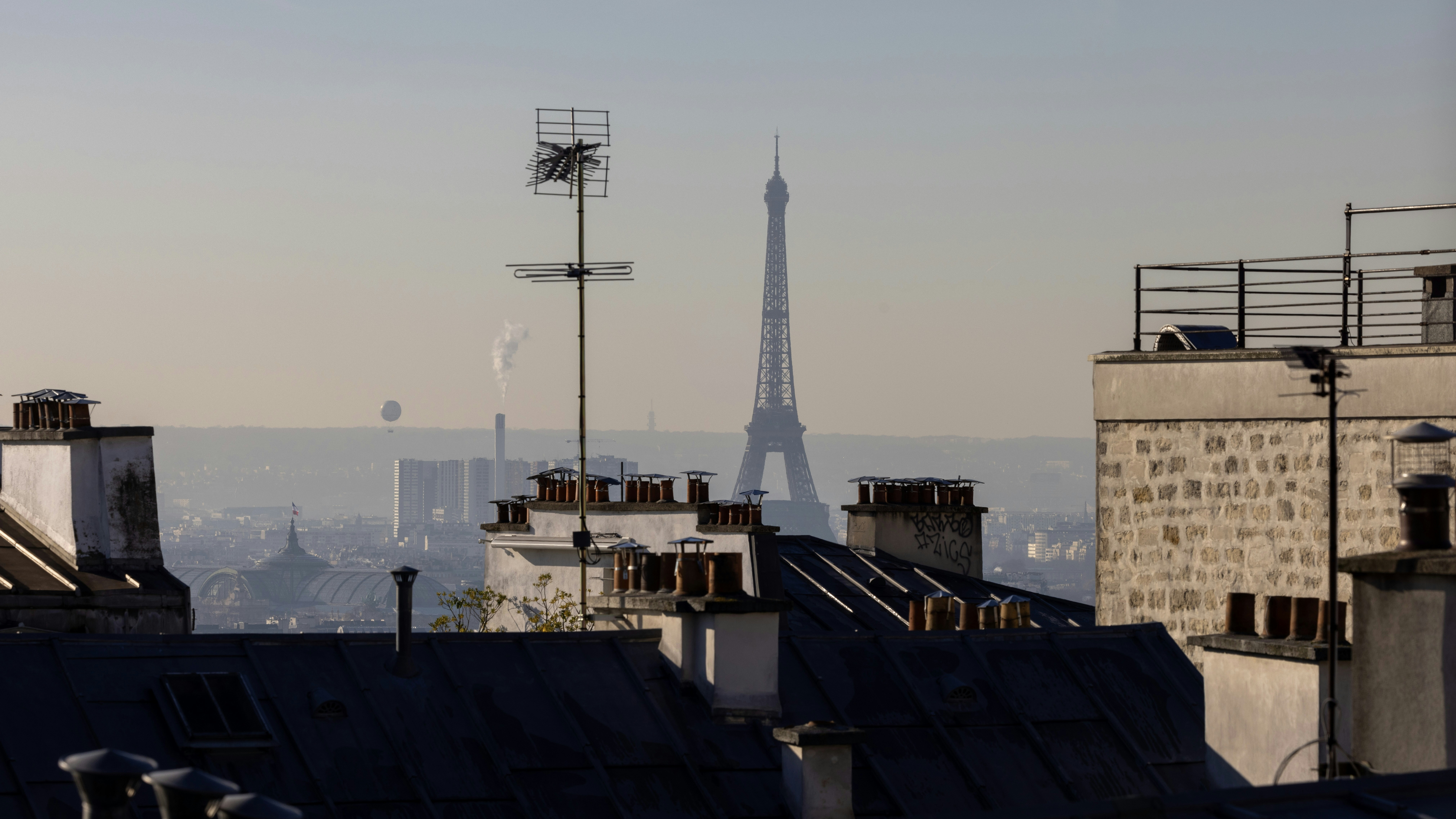Rooftop Silhouette: Eiffel Tower in a Parisian Horizon