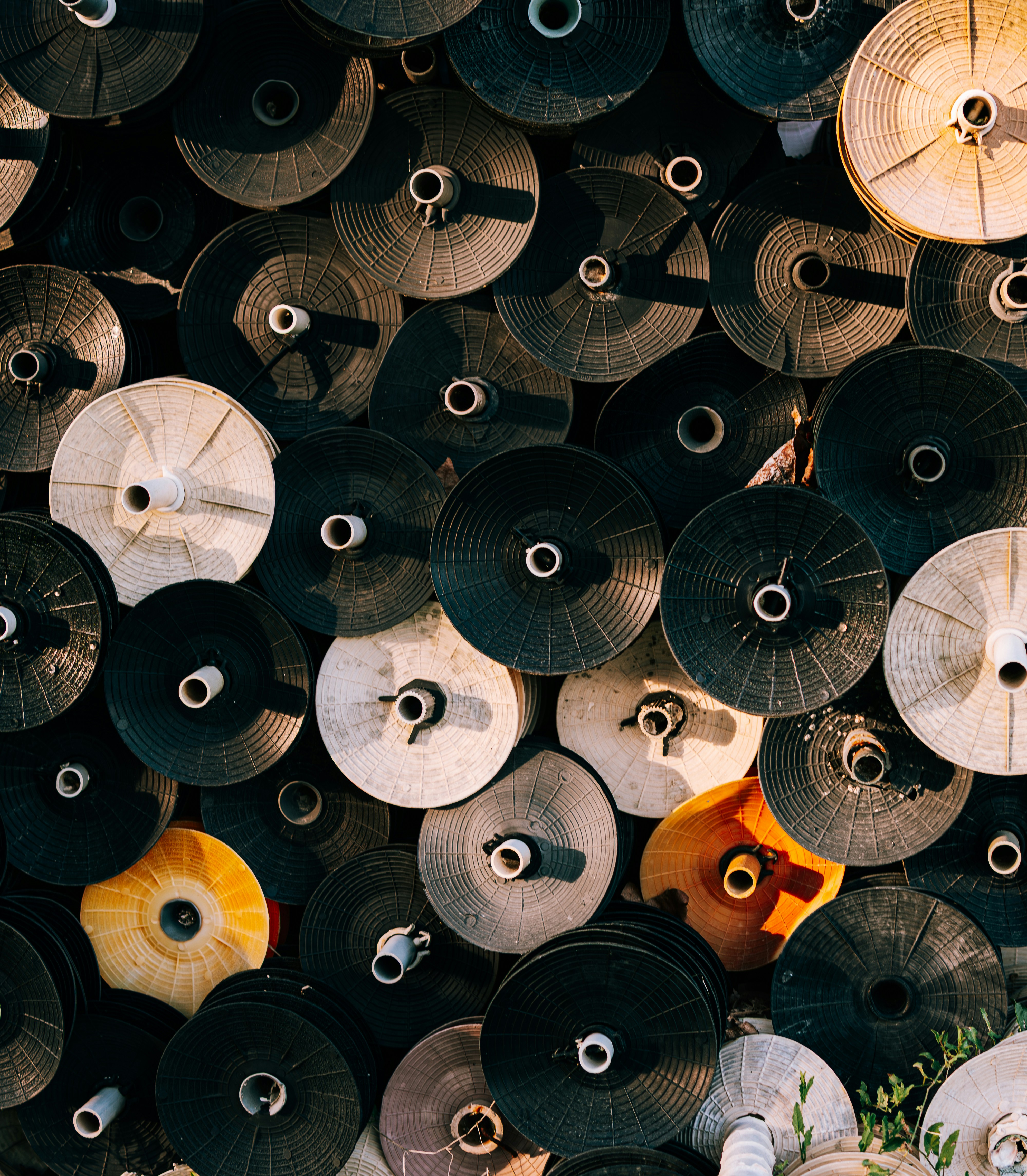 A sea of spools: urban clutter and color pops amid a metallic tide