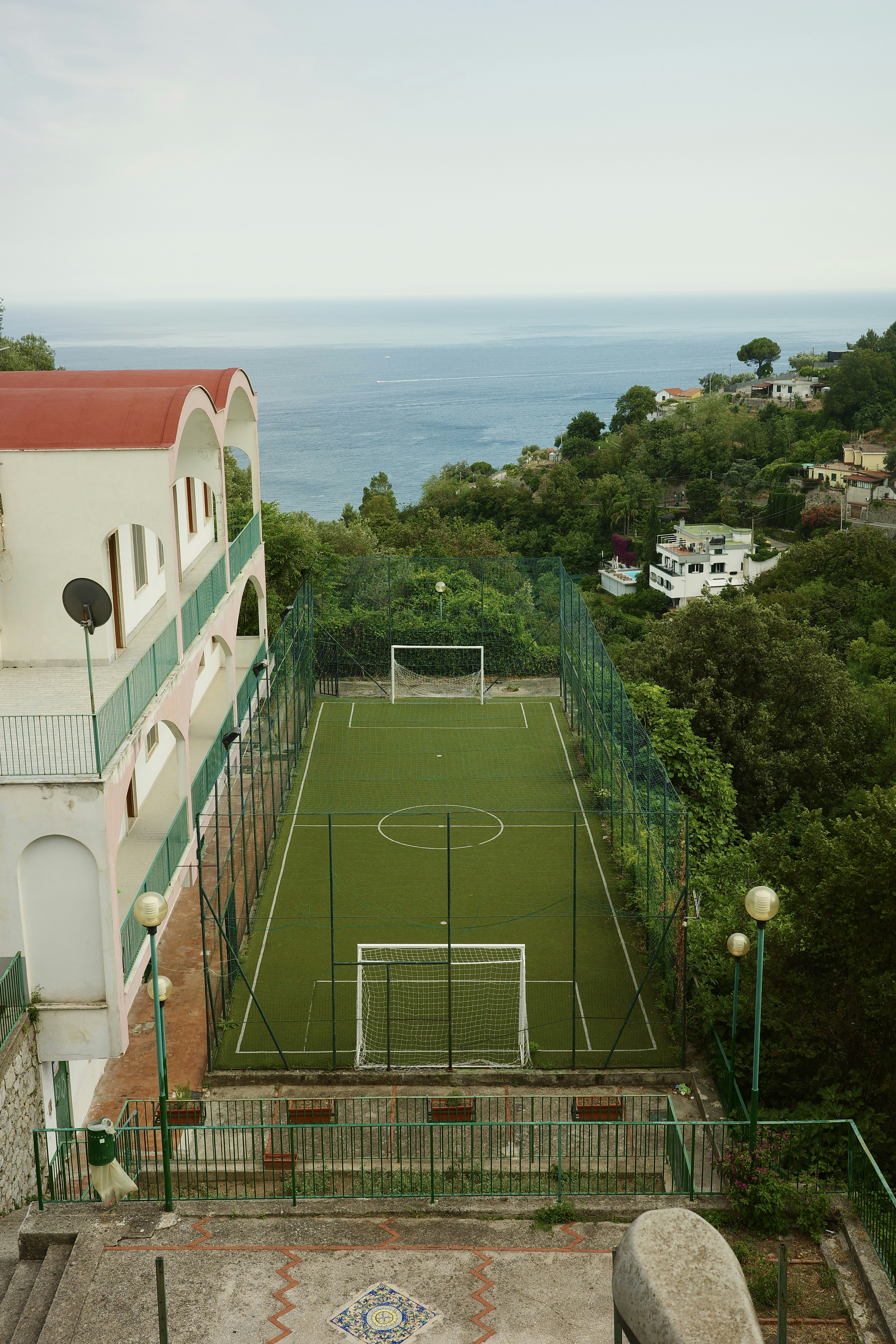 Courtyard Soccer: A Coastal Cliffside Field Surrounded by Greenery